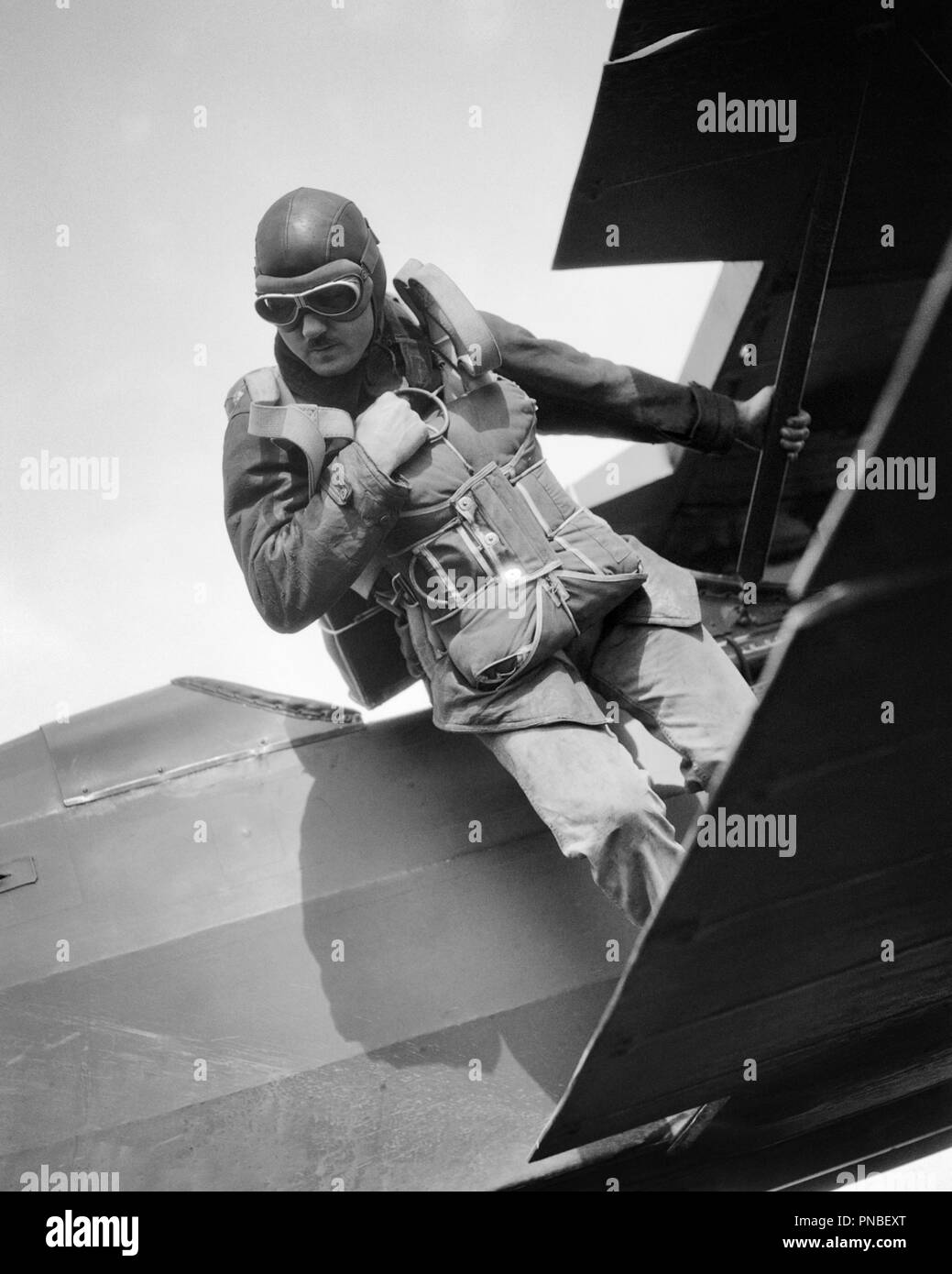 1930s 1940s ANONYMOUS MAN STANDING ON WING OF AIRPLANE ABOUT TO STEP ...