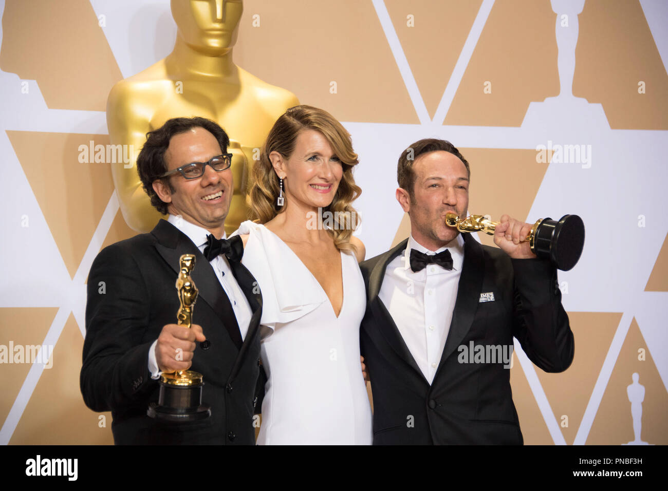 Dan Cogan and Bryan Fogel pose backstage with Laura Dern after winning ...