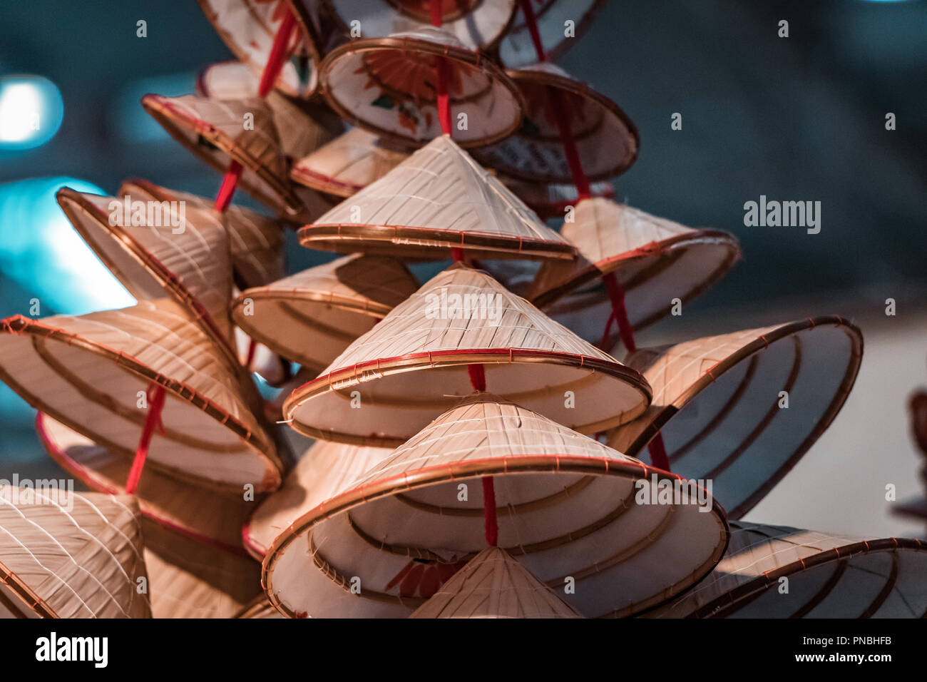 Orinetal, traditional bamboo and straw hats. Stack of conic sun hats ...