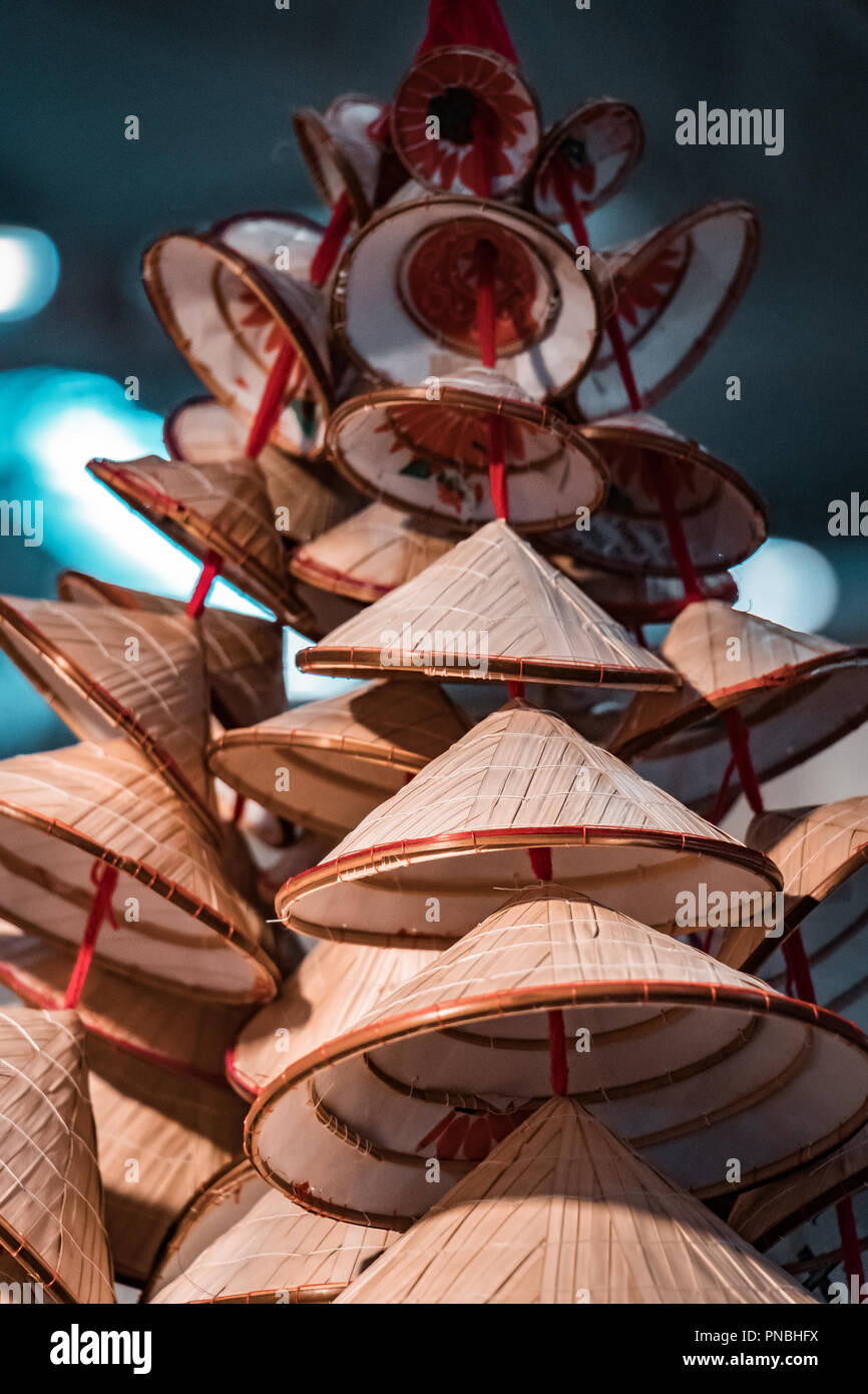 Orinetal, traditional bamboo and straw hats. Stack of conic sun hats ...