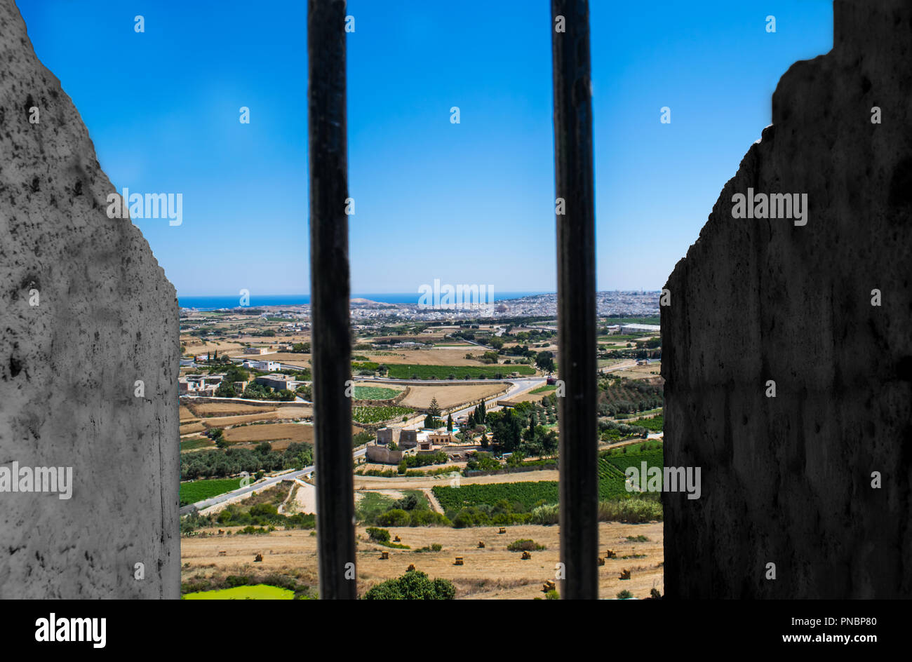 A landscape of Malta from Mdina as seen from behind bars Stock Photo ...