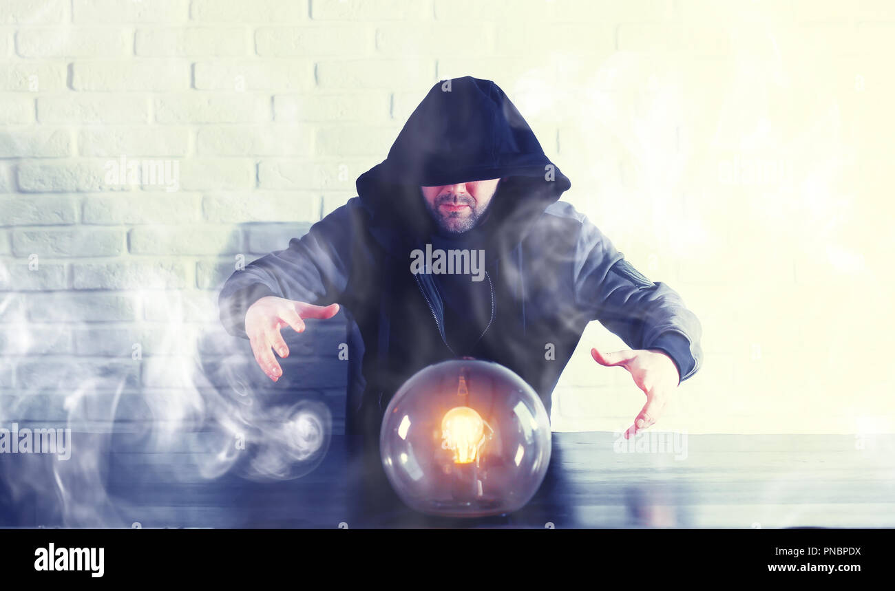 A man with a fortune teller ball Stock Photo - Alamy