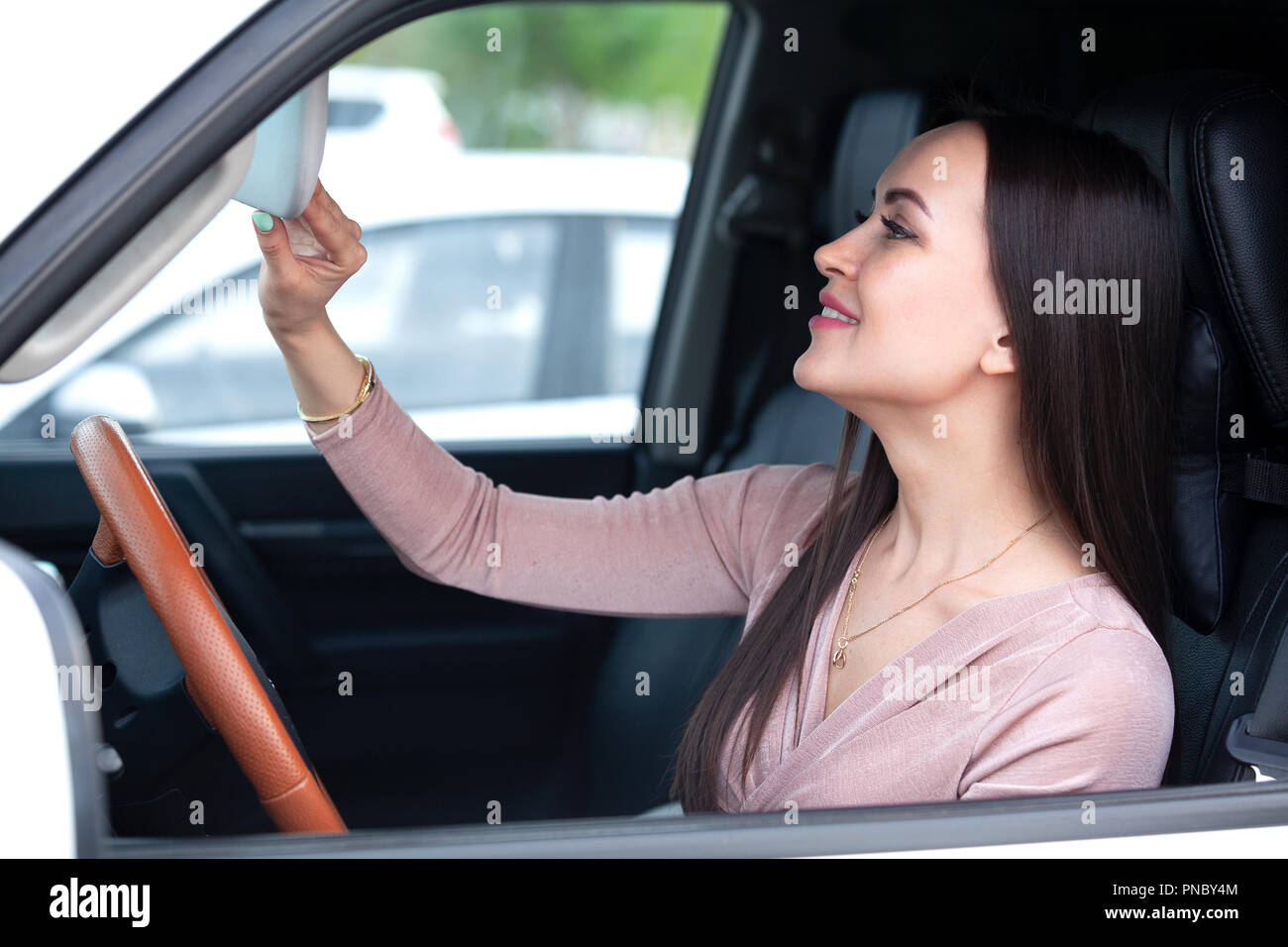 Pretty woman driver in a car Stock Photo - Alamy