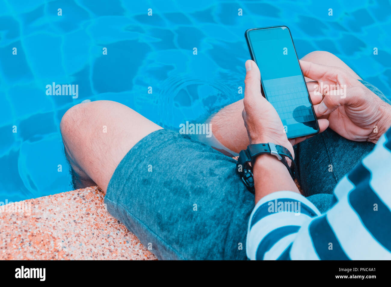 Modern man using cellphone on the pool Stock Photo - Alamy
