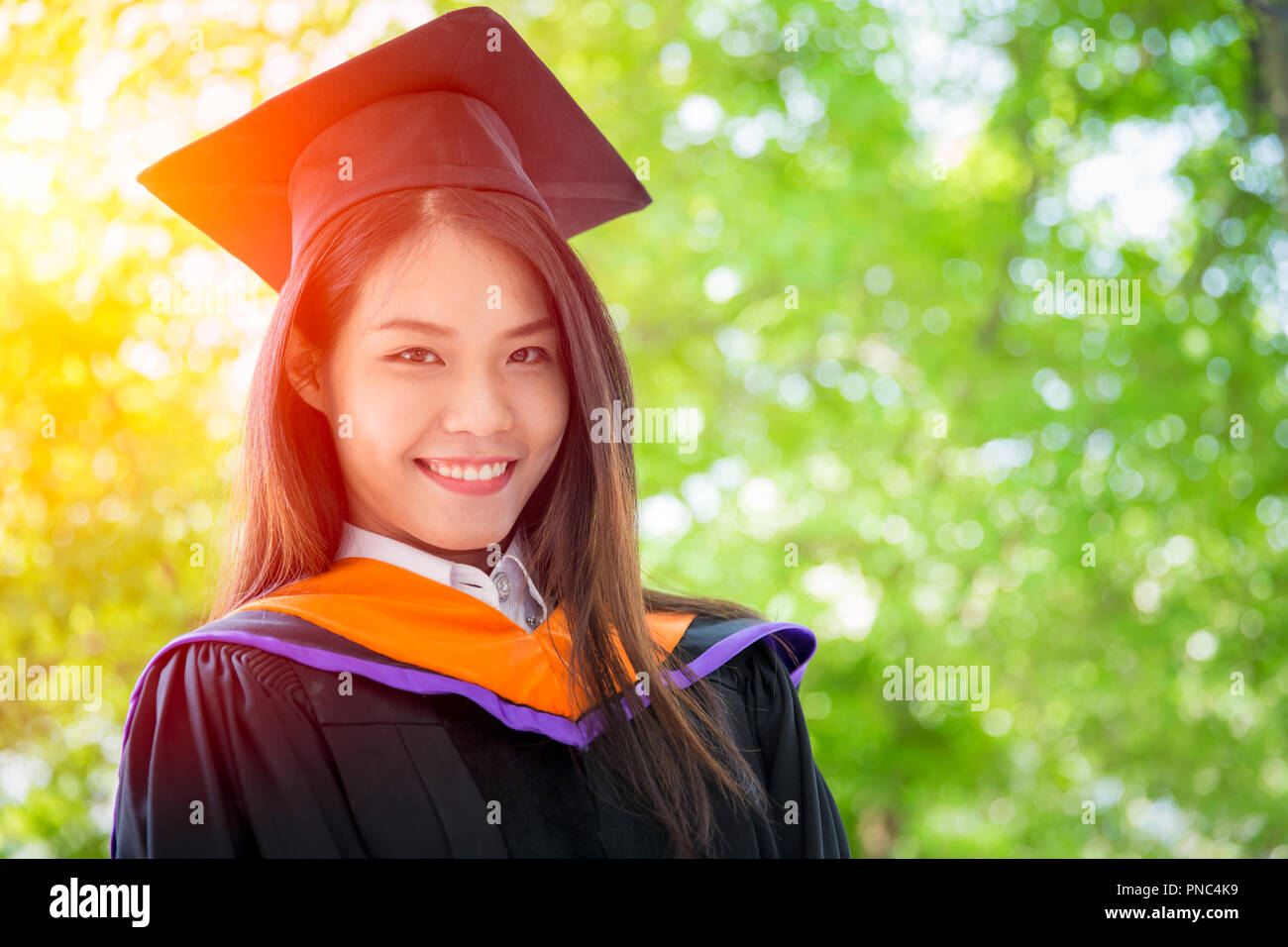 Asian cute women portrait graduation with green nature background ...