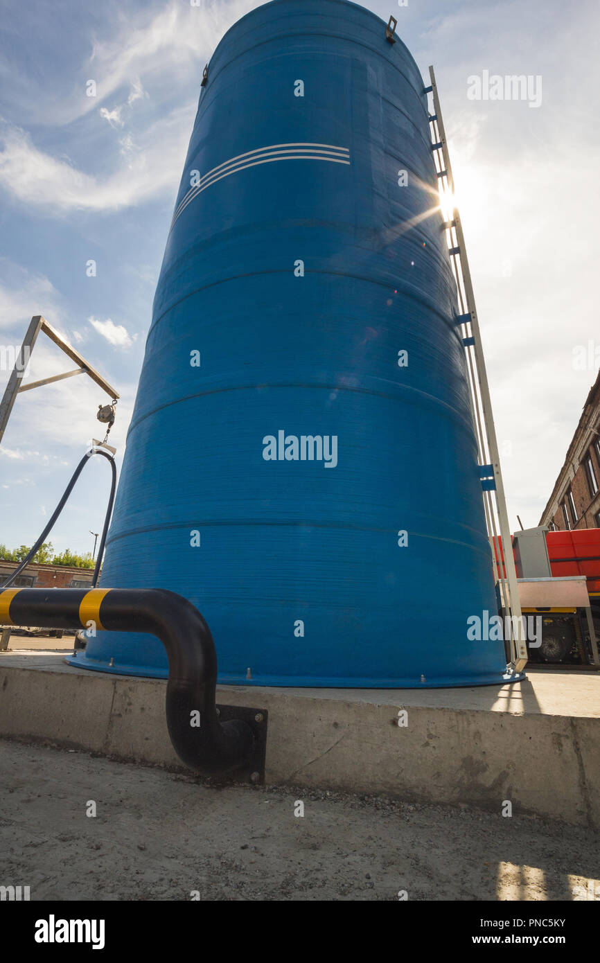 Blue water tower with a white staircase and a black hose Stock Photo ...