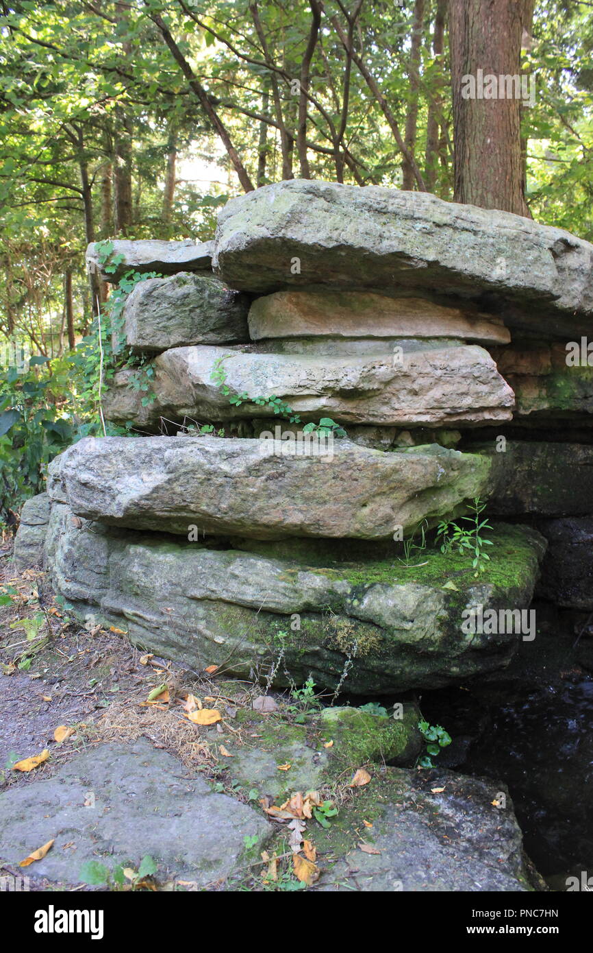 Professionally landscaped stack of weathered limestone rocks located on ...