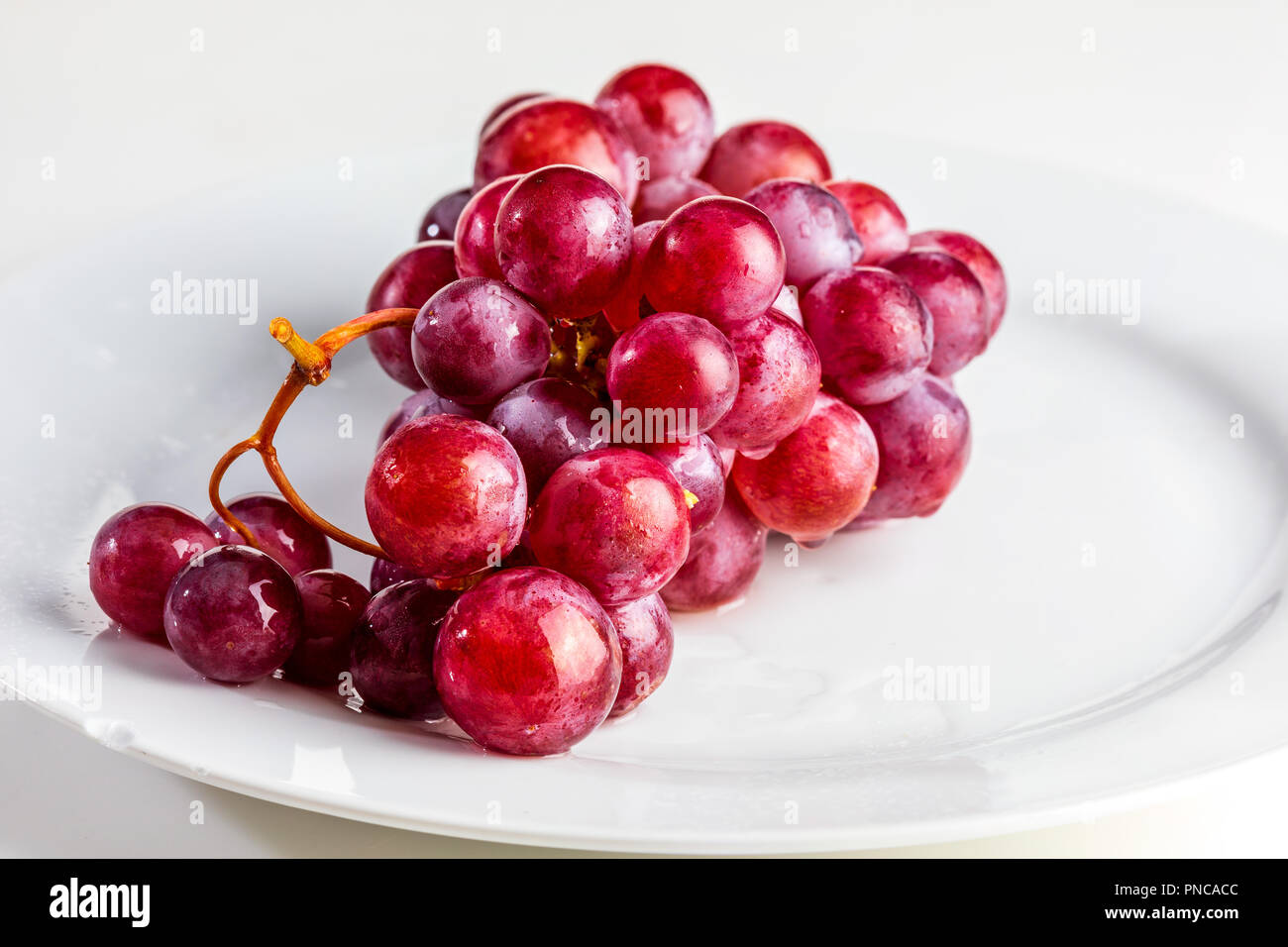 Beautiful close-up of cluster of red grapes (inks) on table. Fresh, raw ...