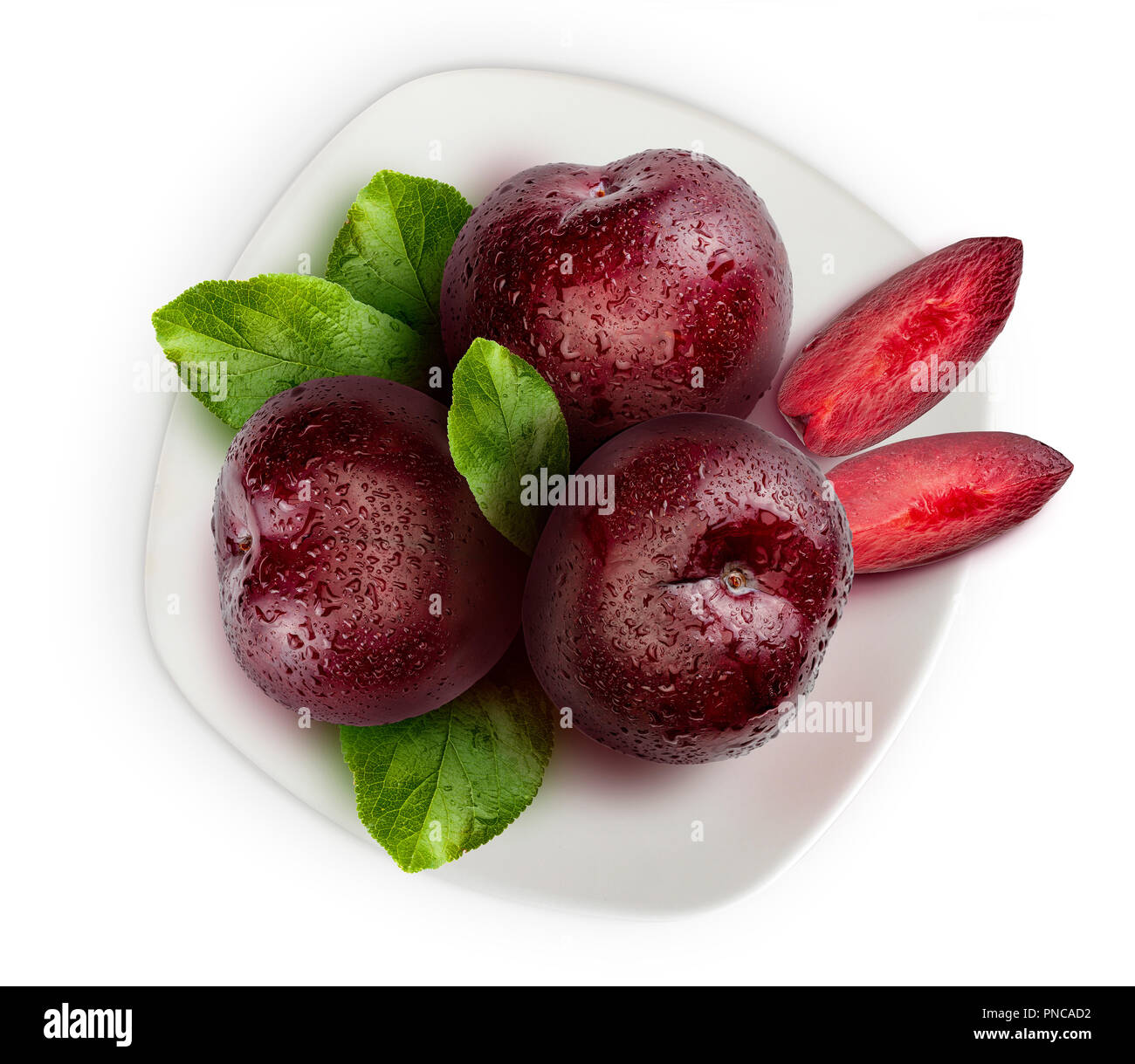 Appetizing and healthy red plums, whole and cut into segments with an ...