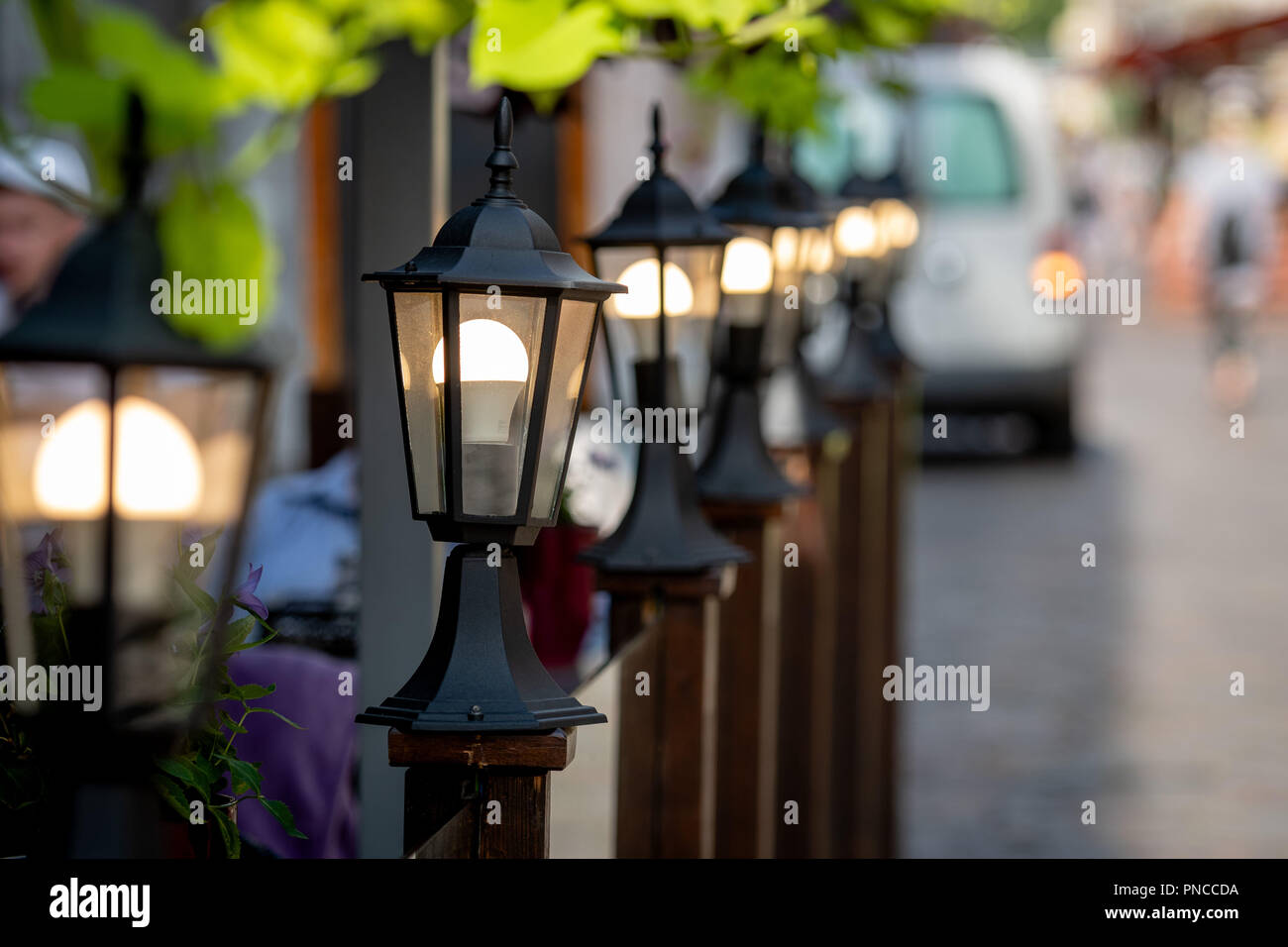 Decorative lanterns along the street cafe barrier Stock Photo - Alamy