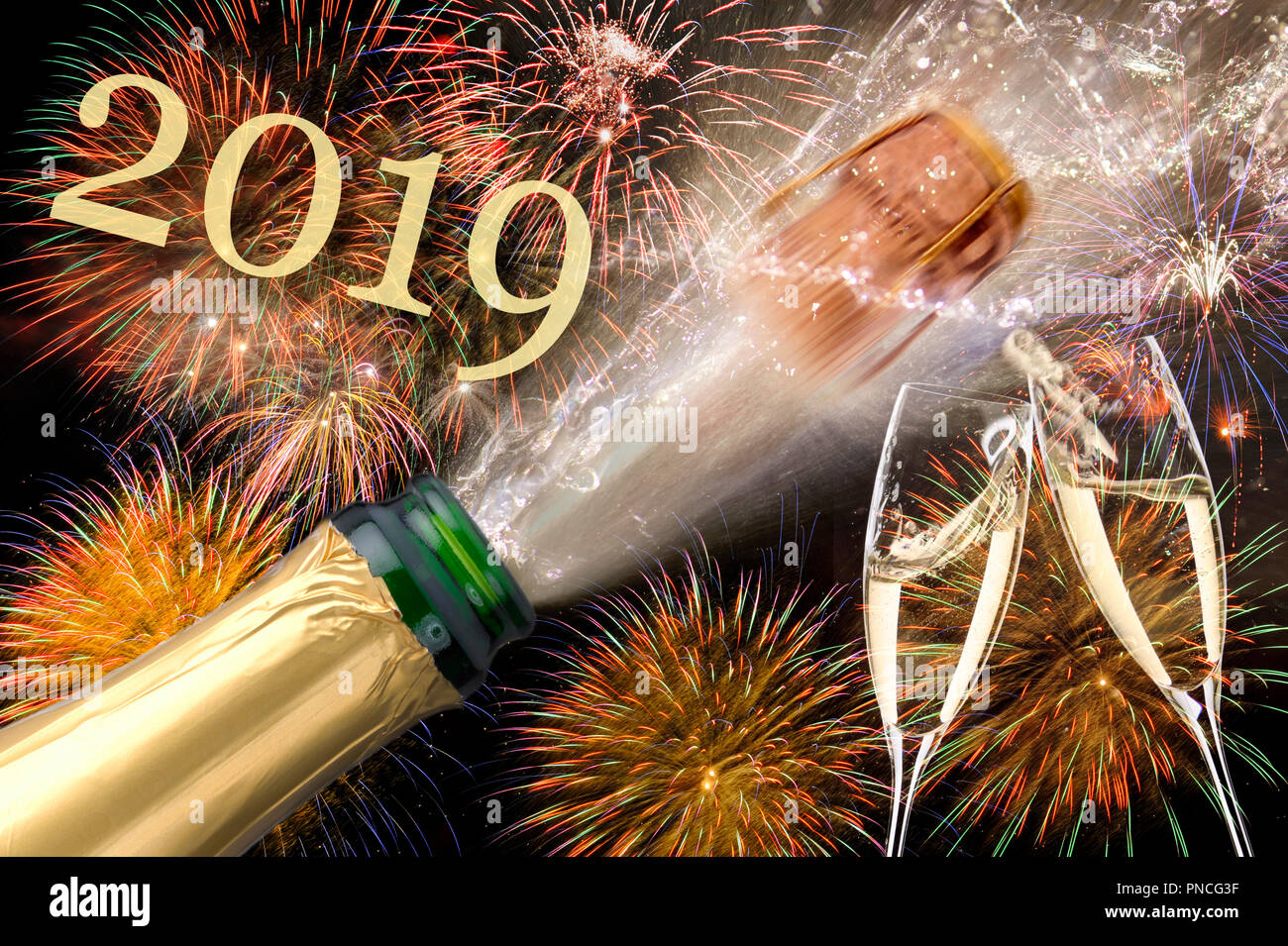 splashing bottle of champagne with flying cork and firework at ...