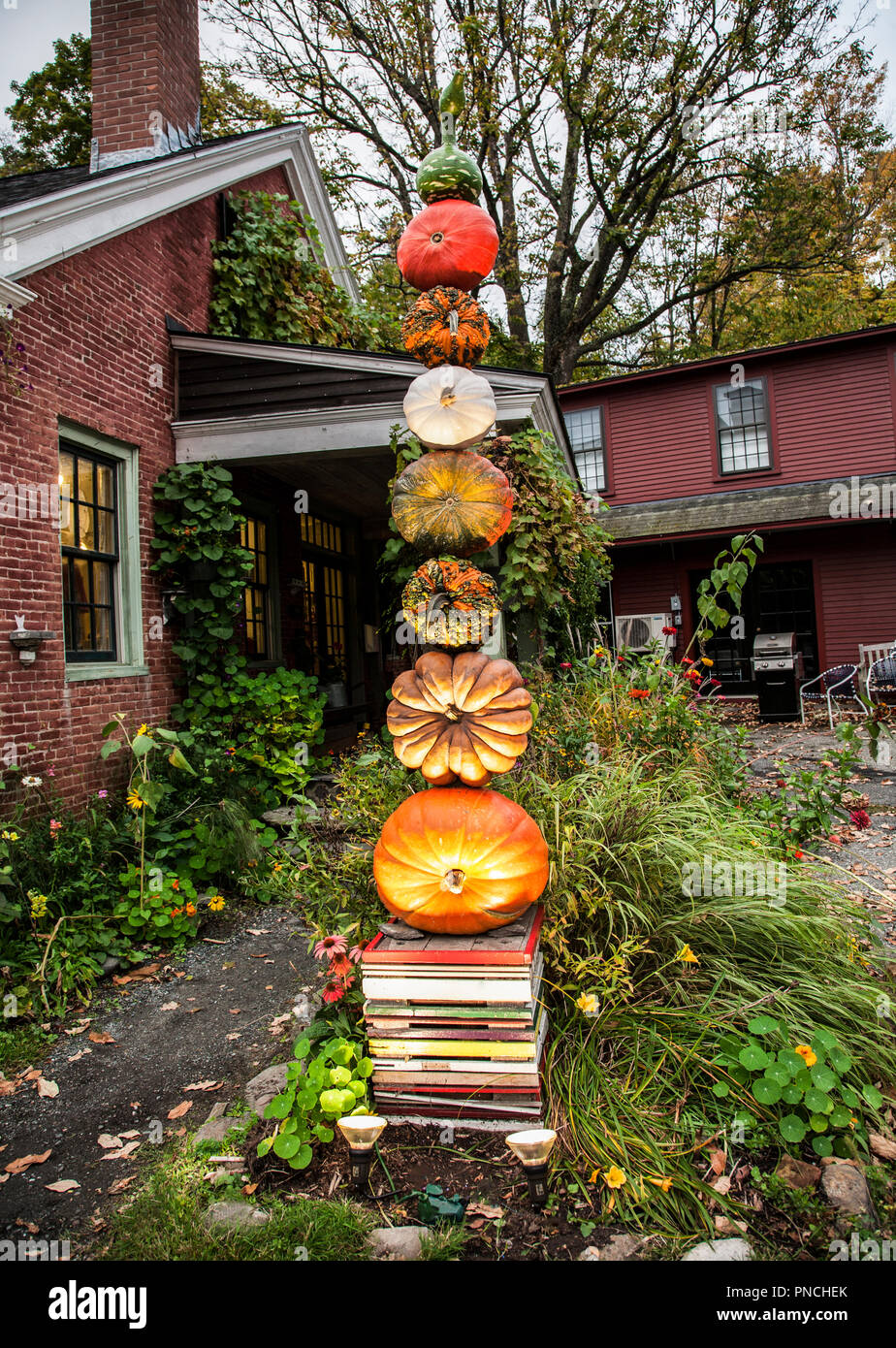 Pumpkin totem pole with orange pumpkins in a garden, Fall colours ...