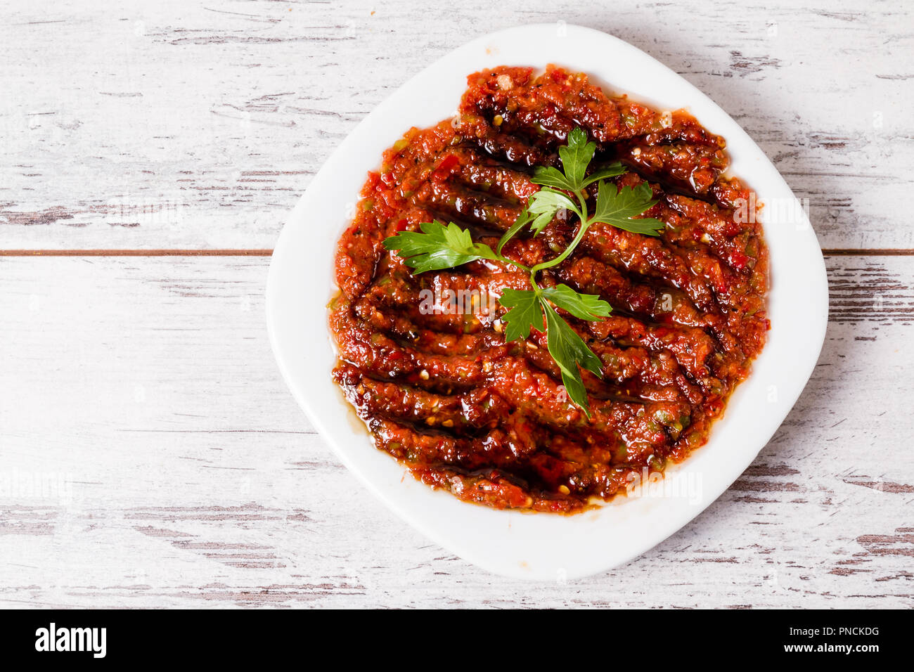 Spicy appetizer with mashed tomato and bitter red pepper Stock Photo ...