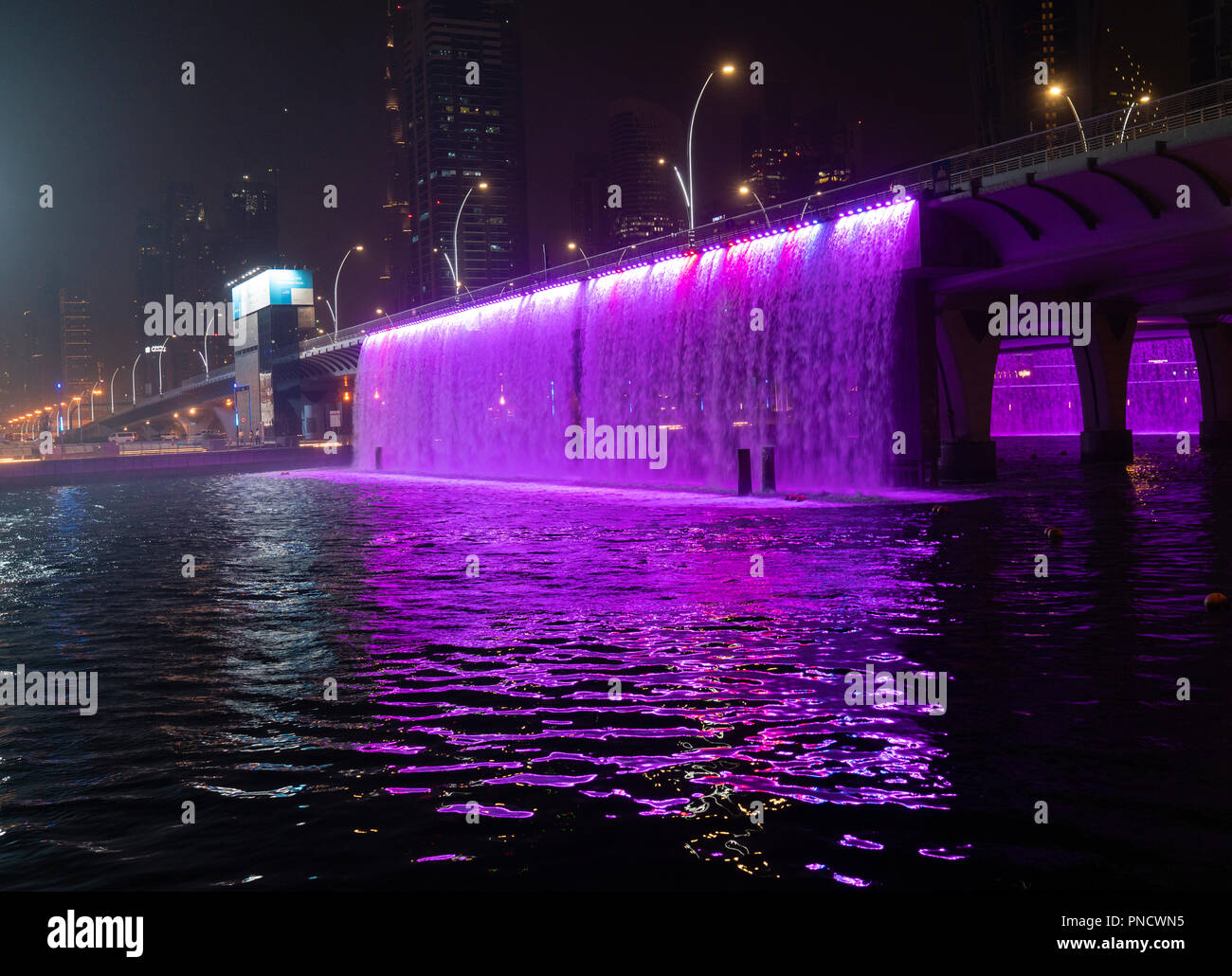 Illuminated waterfall from motorway bridge at night as part of the ...