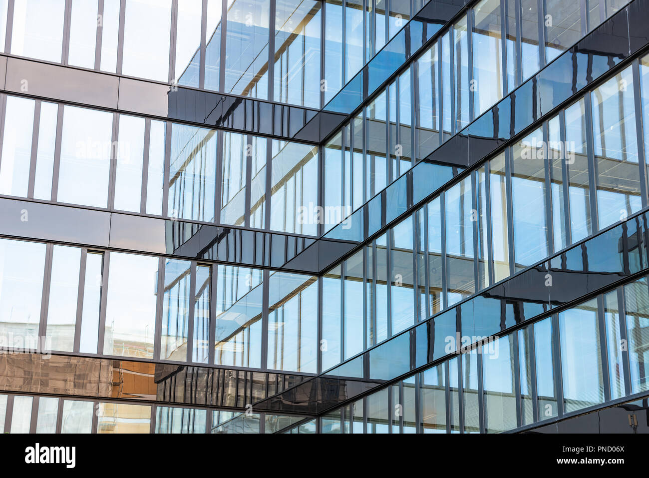 mirror effect on the facade of the office building Stock Photo - Alamy