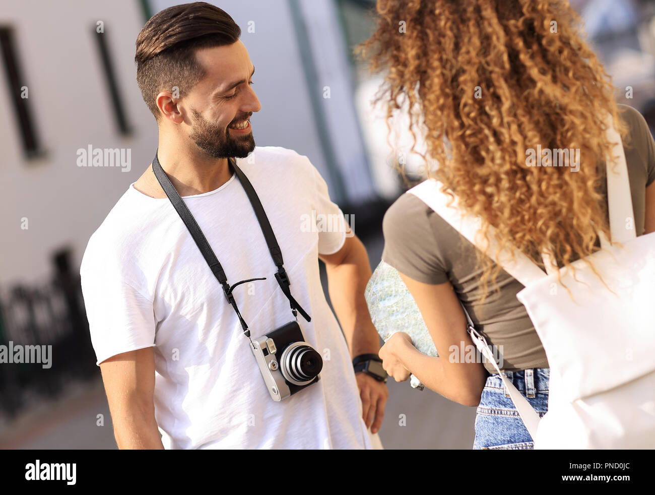Young couple walking and looking at a guide while looking happy Stock ...