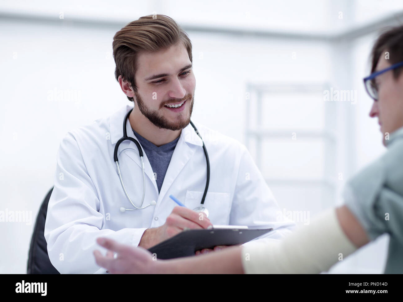 doctor writing a prescription to her patient Stock Photo - Alamy