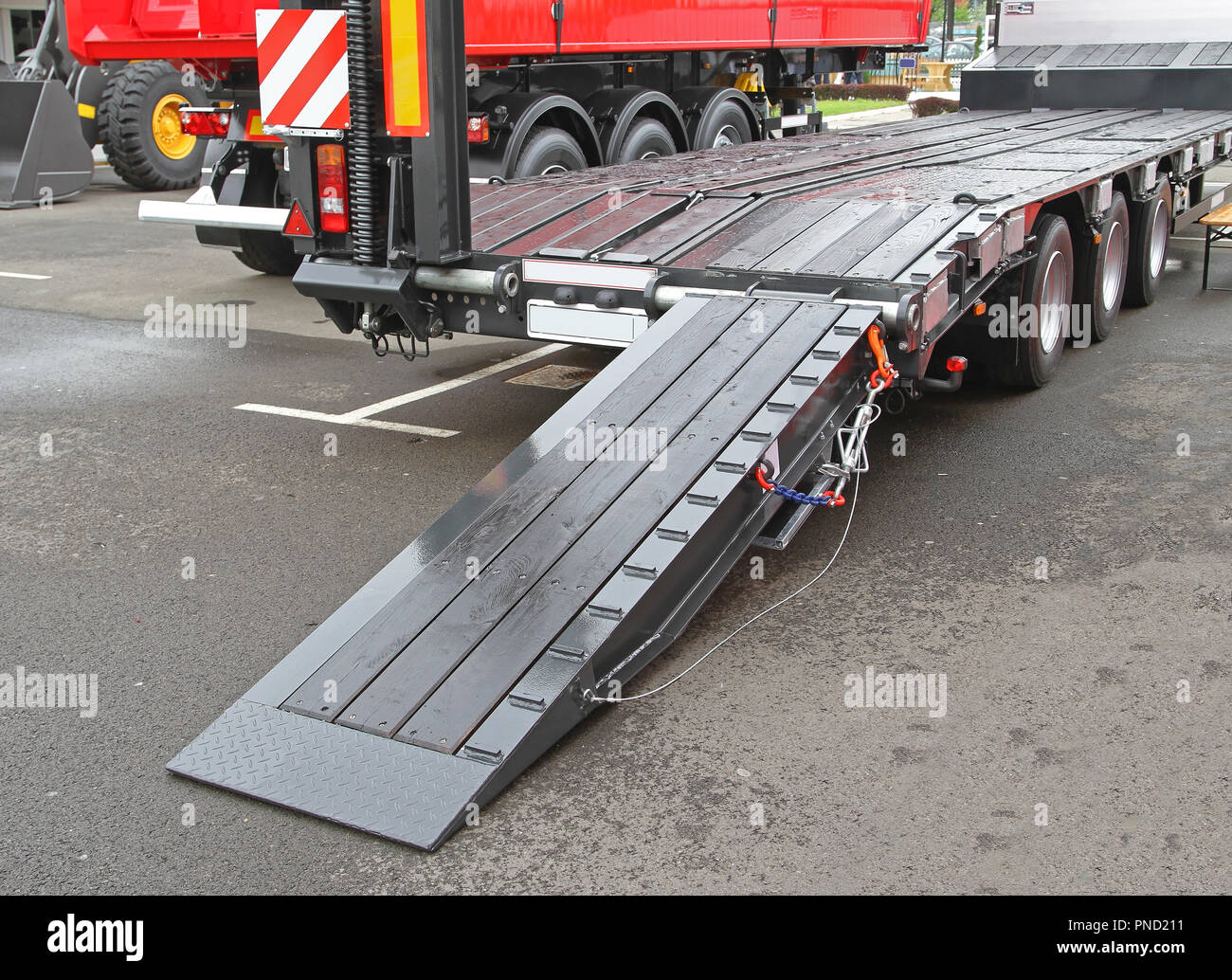 Heavy Equipment Transport Flat Bed Trailer With Loading Ramp Stock ...