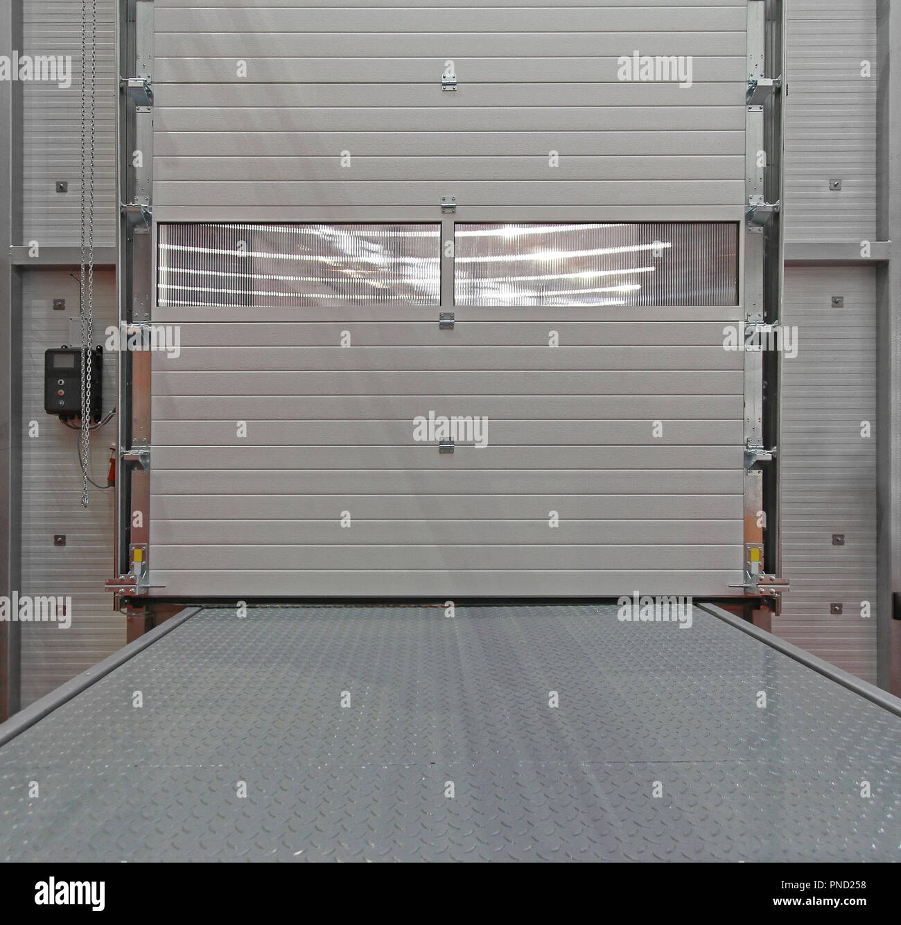Industrial Roll Loading Cargo Door in Warehouse Stock Photo - Alamy