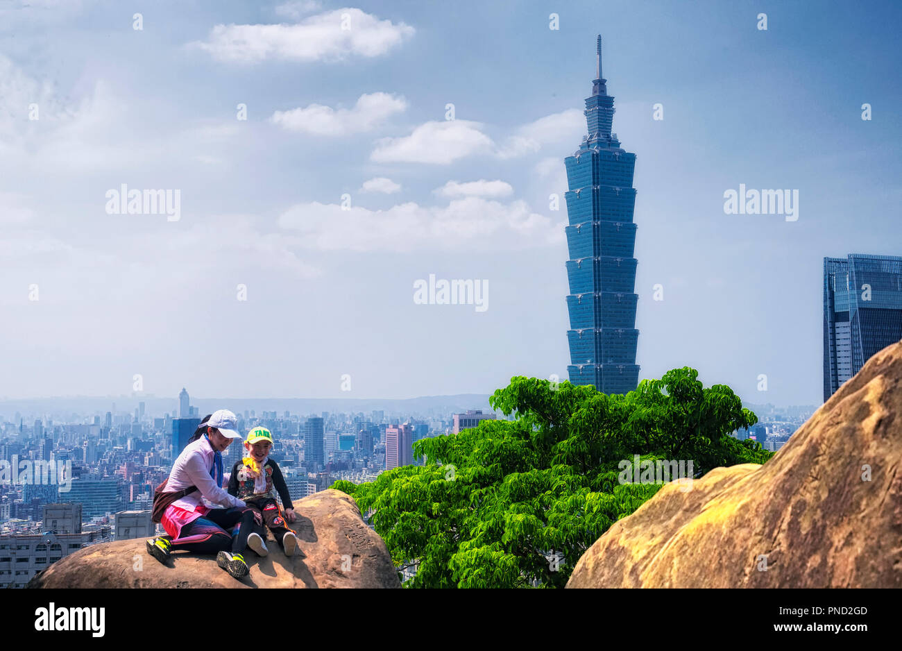 April 1, 2018. Taipei, Taiwan. A mother and daughter posing on rocks ...