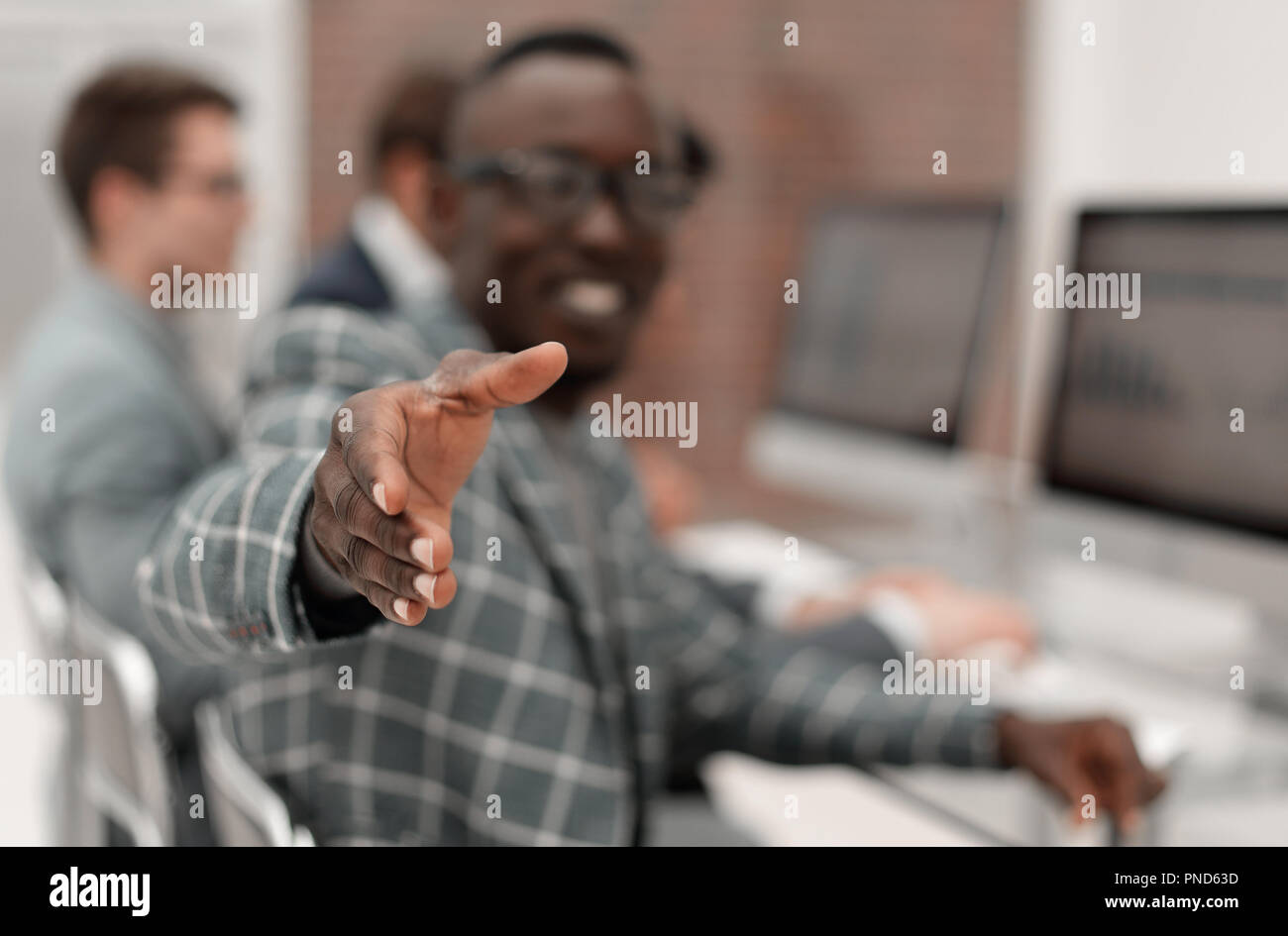 young businessman reaching out for a handshake Stock Photo - Alamy