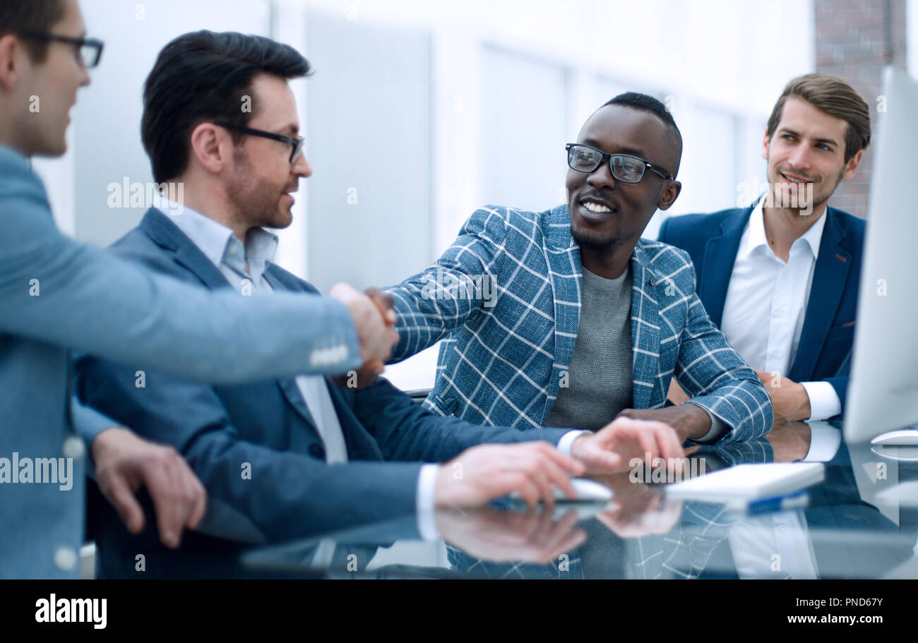handshake colleagues sitting at the Desk Stock Photo - Alamy