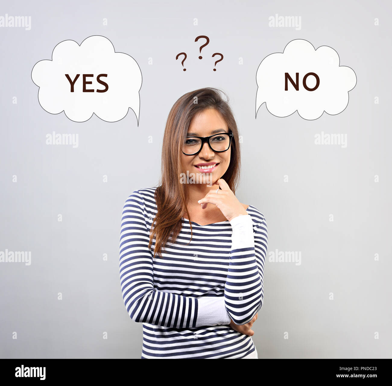Thinking smiling young latina woman in glasses with two empty choice ...