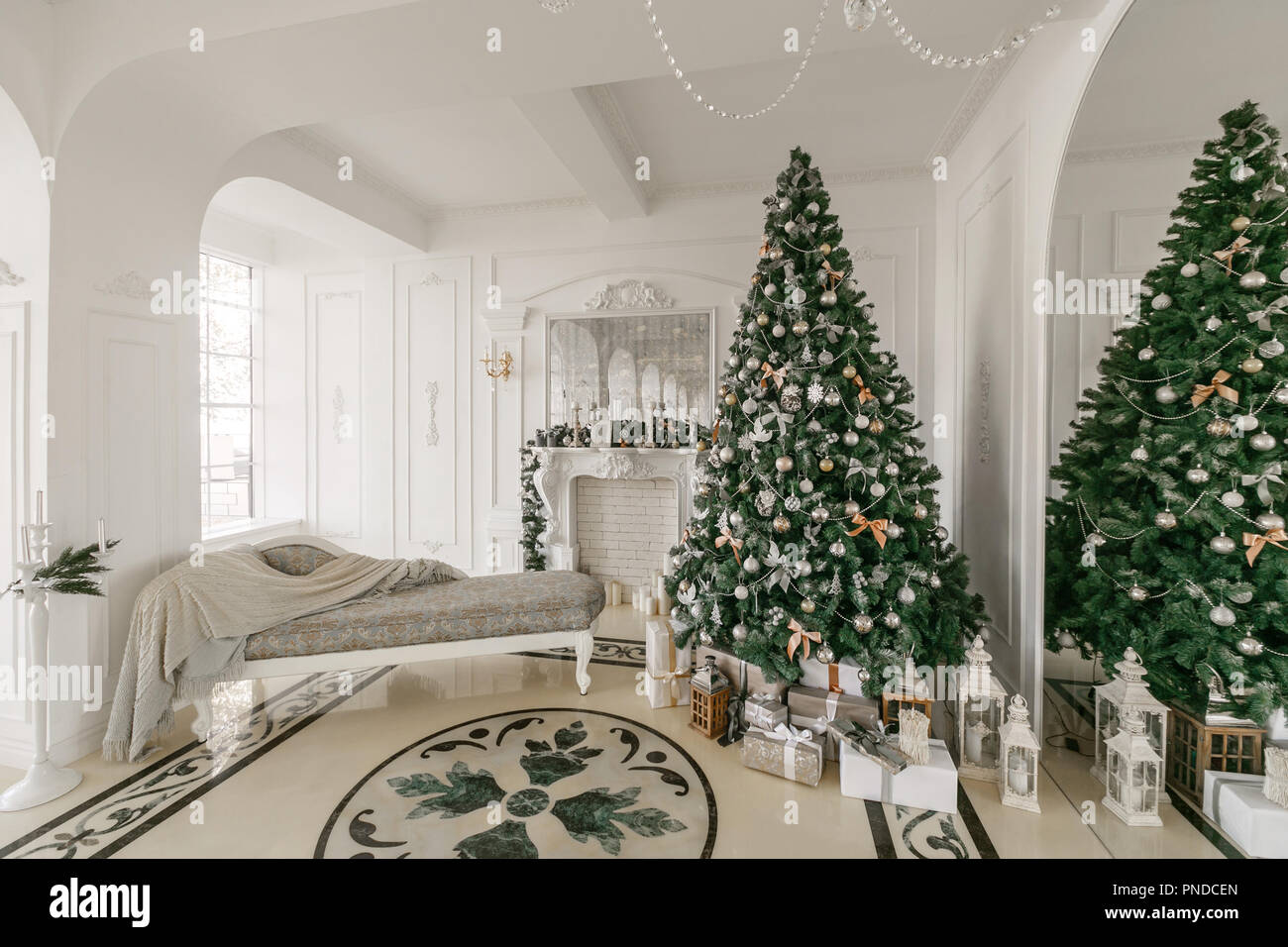 gifts at the Christmas tree. Christmas morning. classic luxurious ...