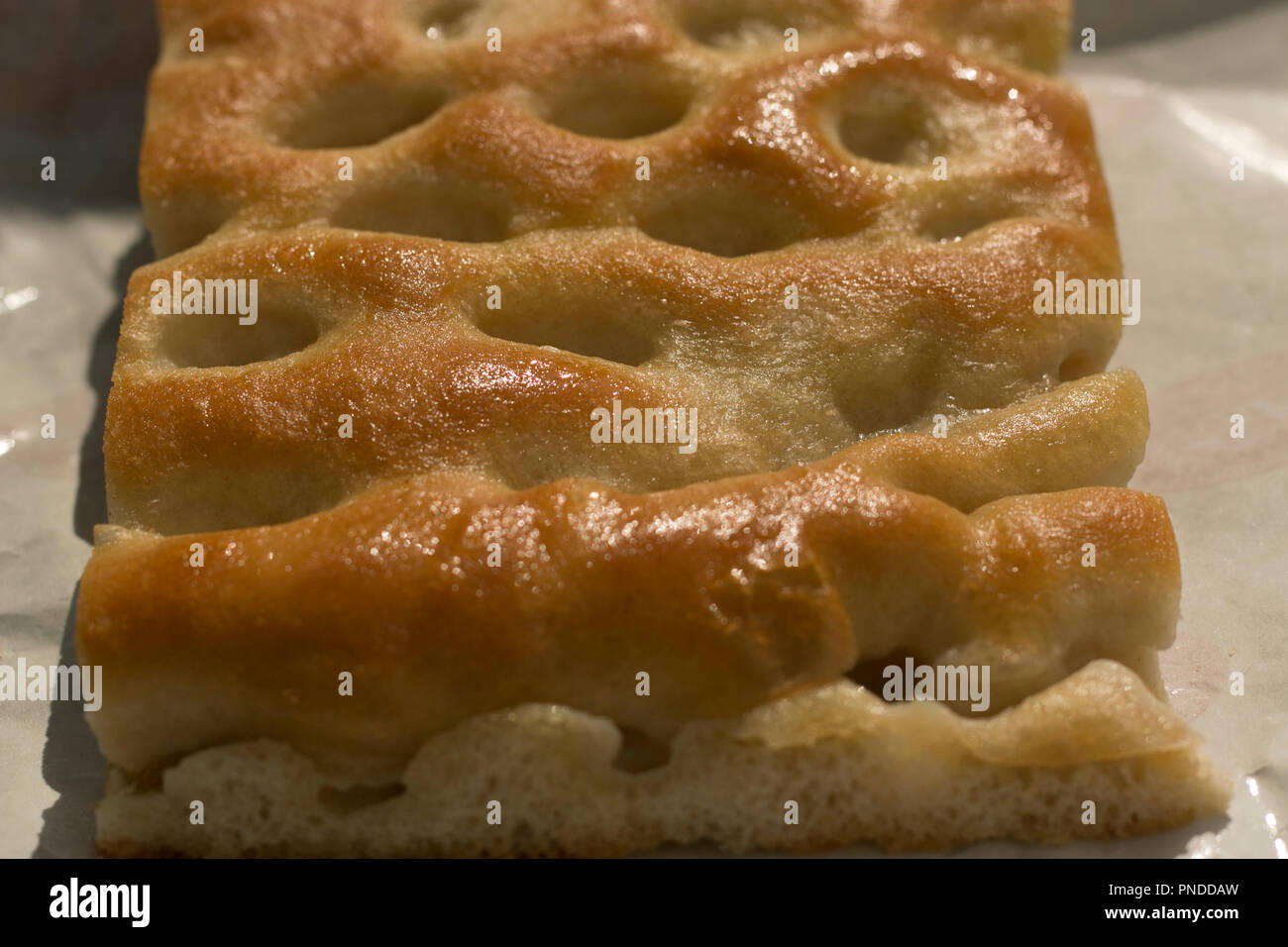 Close-up of a slice of focaccia, an italian oily bread typical of ...