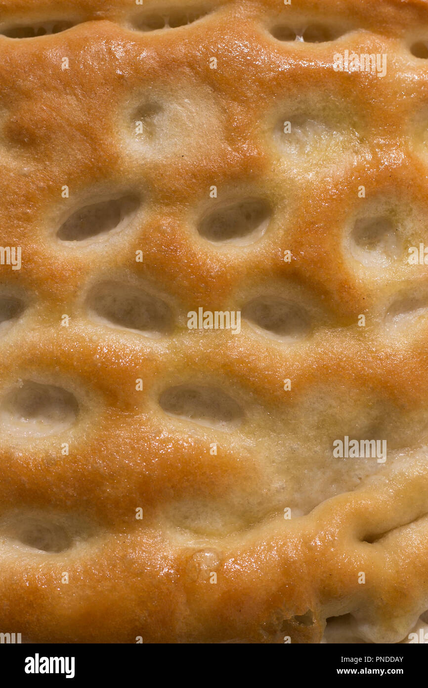 Close-up, full page image of a slice of focaccia, an italian oily bread ...
