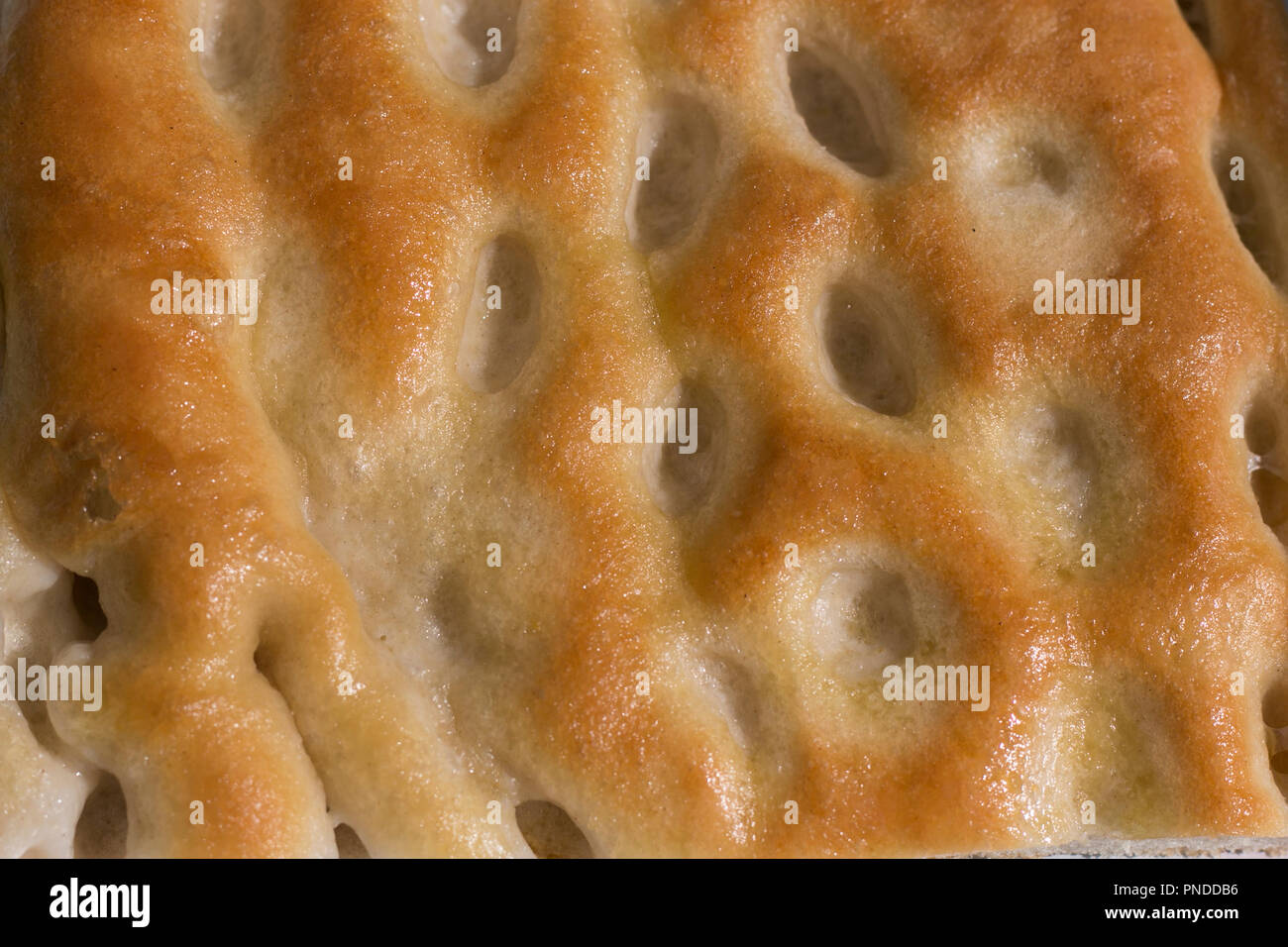 Close-up, full page image of a slice of focaccia, an italian oily bread ...