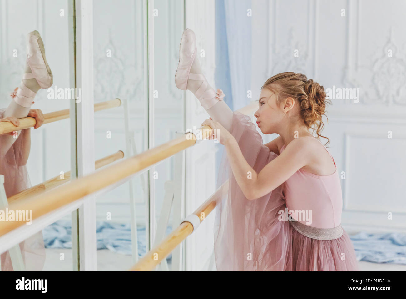 Young classical ballet dancer girl in dance class. Beautiful graceful ...