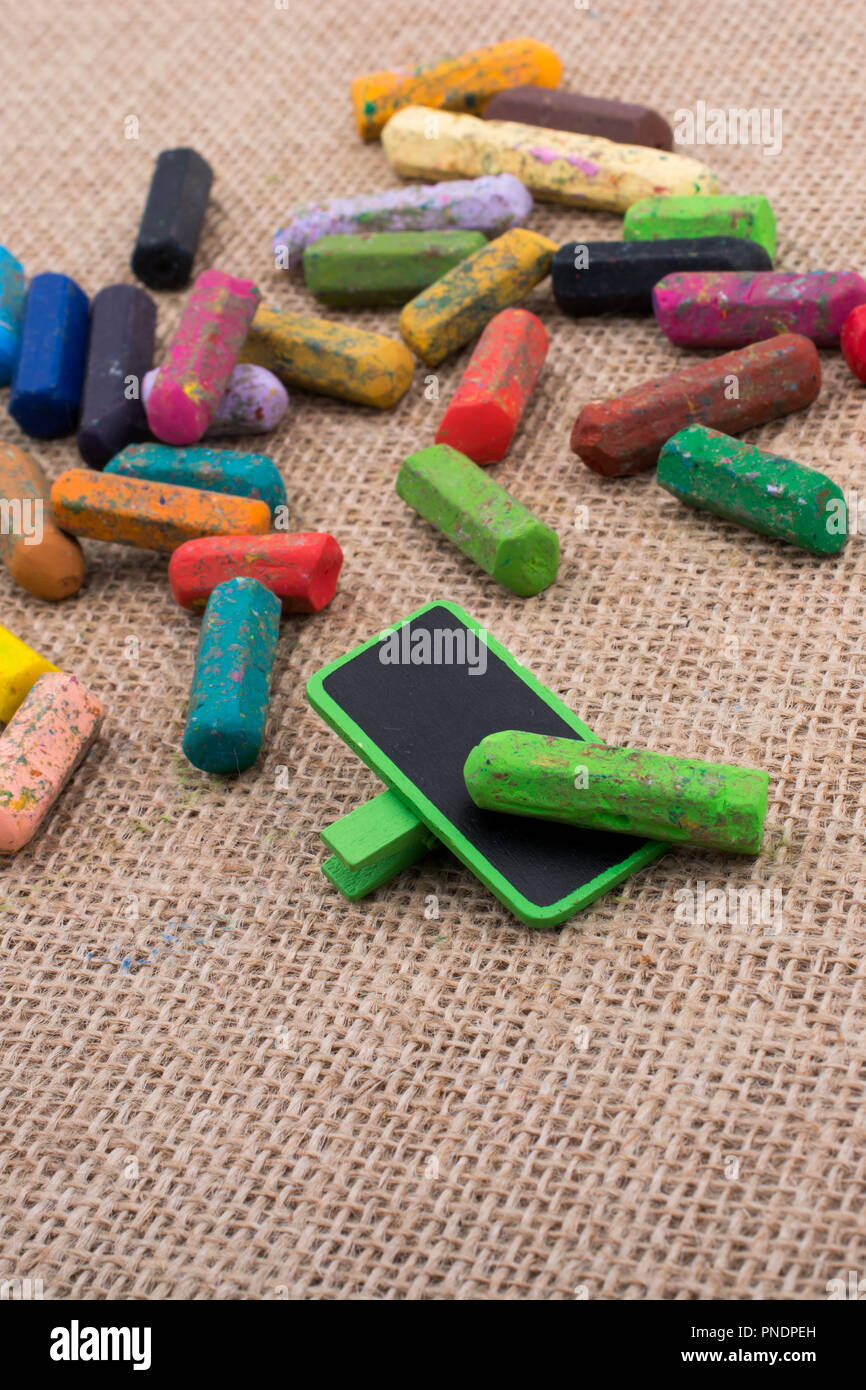 Used crayons of various color and a notice board Stock Photo - Alamy