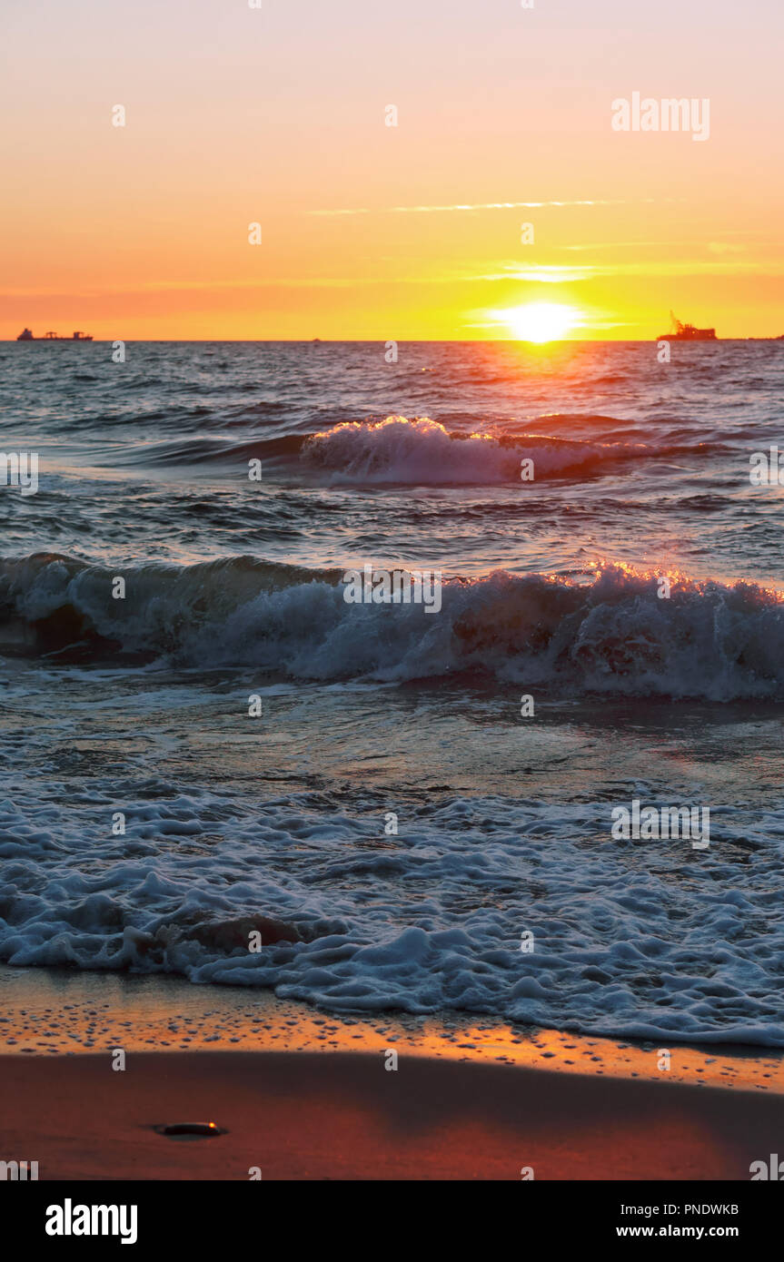 Sunset over the sea. Reflection of sunlight in the sea waves. Red sky ...