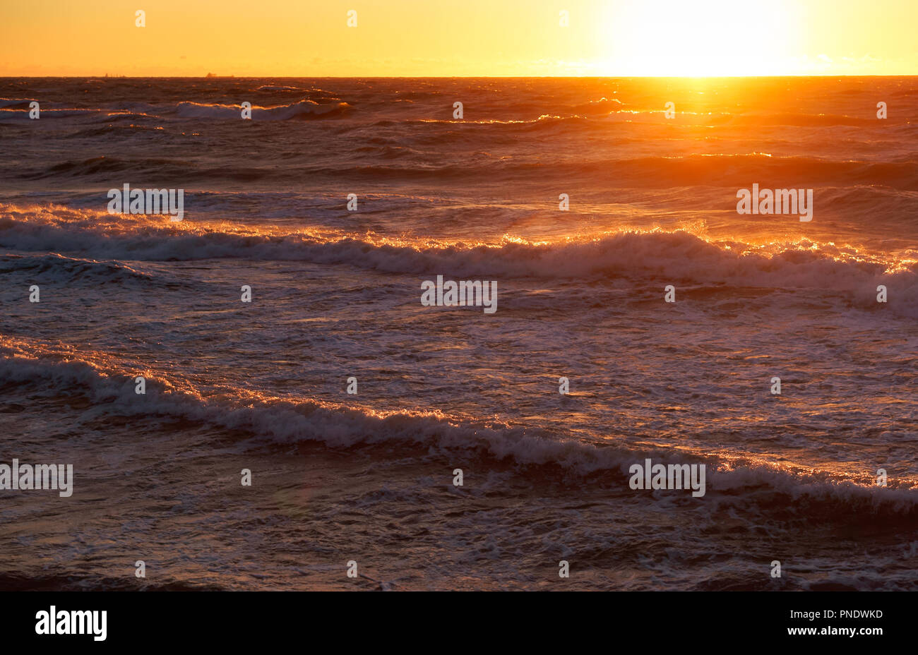 Sunset over the sea. Reflection of sunlight in the sea waves. Red sky ...