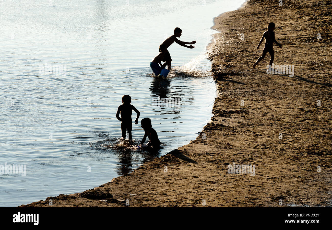 children playing in the river Stock Photo - Alamy