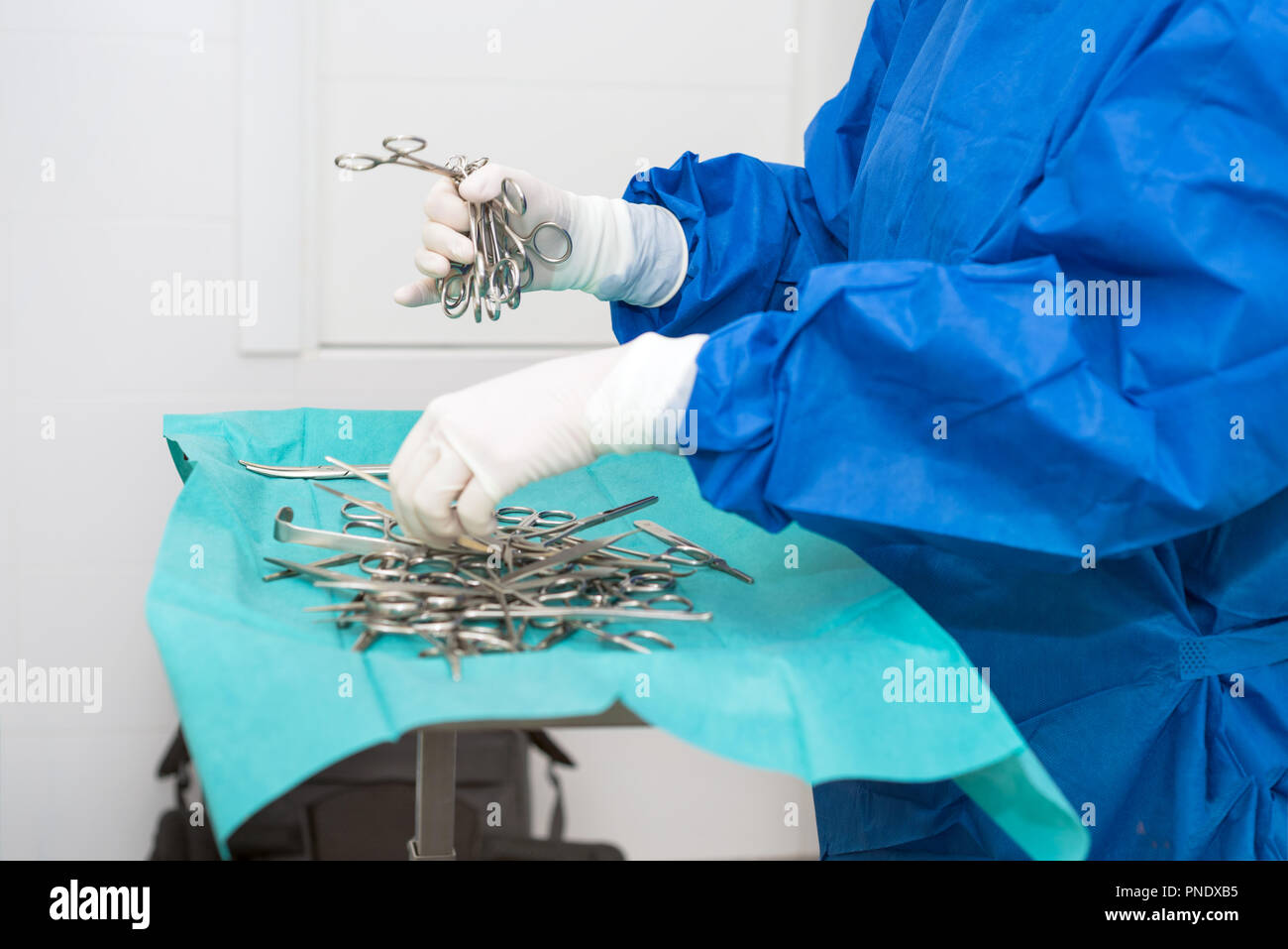 Scrub nurse preparing medical instruments for operation Stock Photo - Alamy