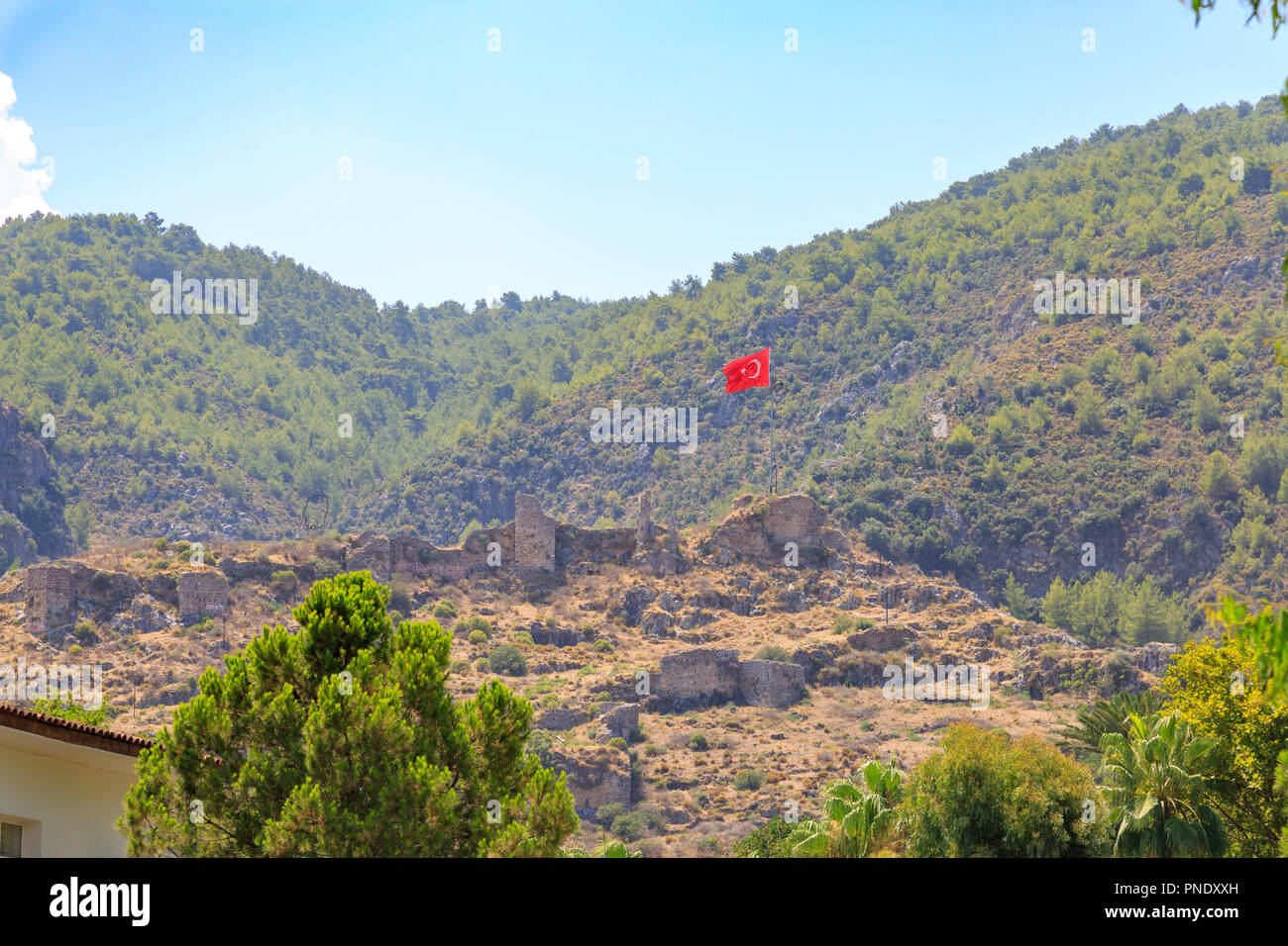 Fethiye castel view from city with turkish flag in Fethiye, Turkey ...