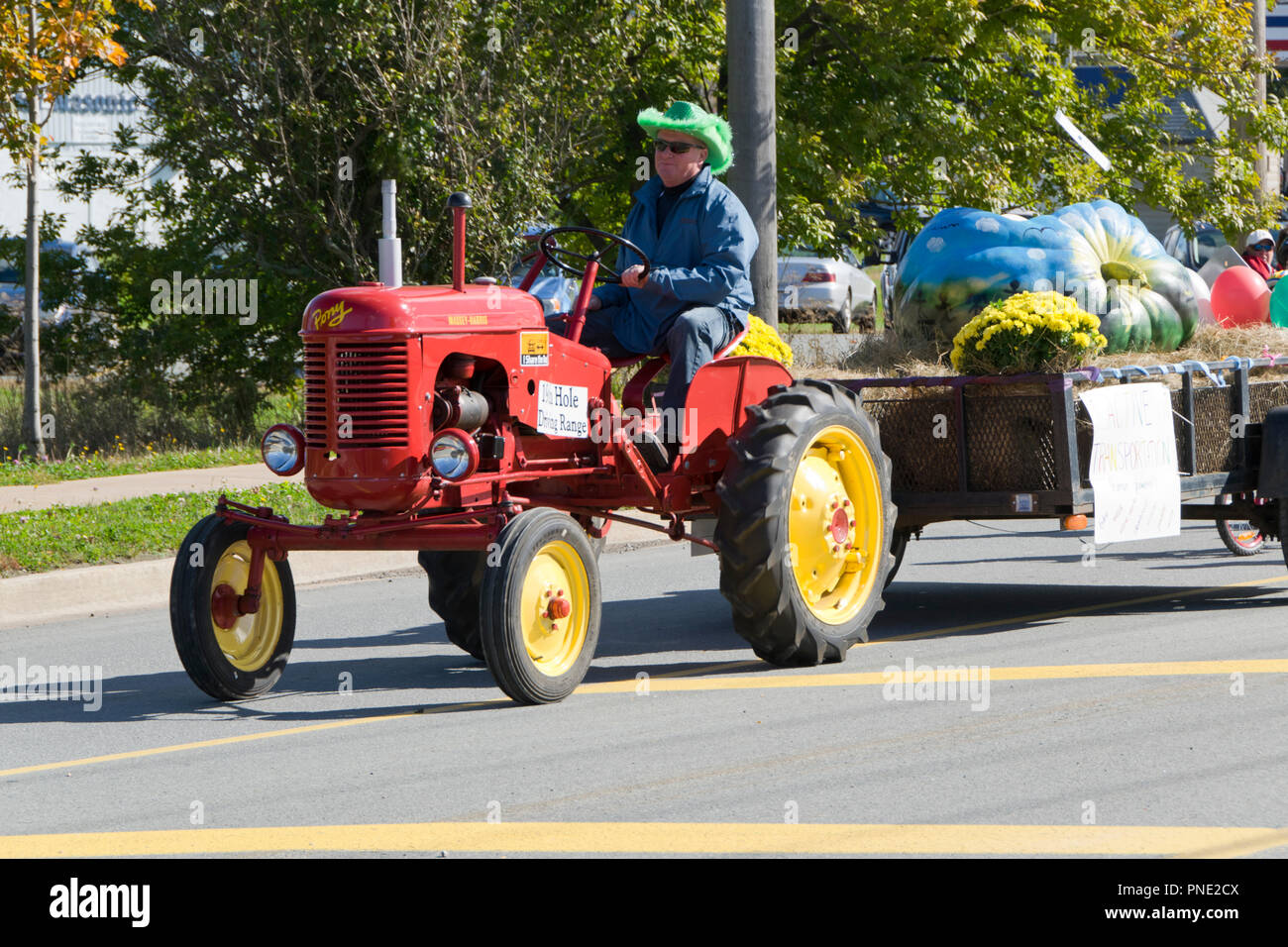 Old red tractor pulling large pumpkin at the parade Stock Photo - Alamy
