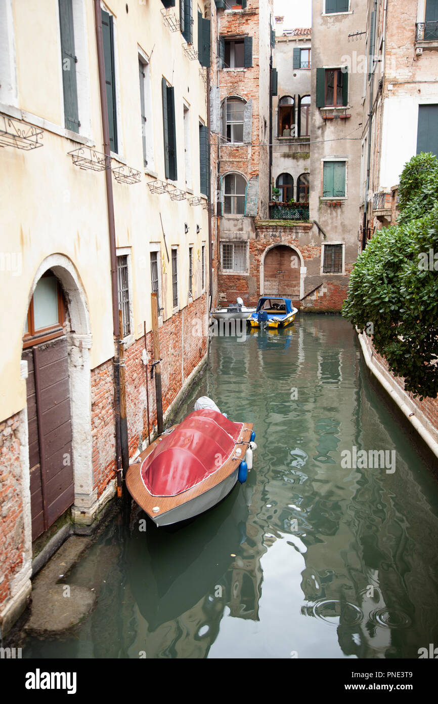 red boat docked in the canal in Venice Italy Stock Photo - Alamy