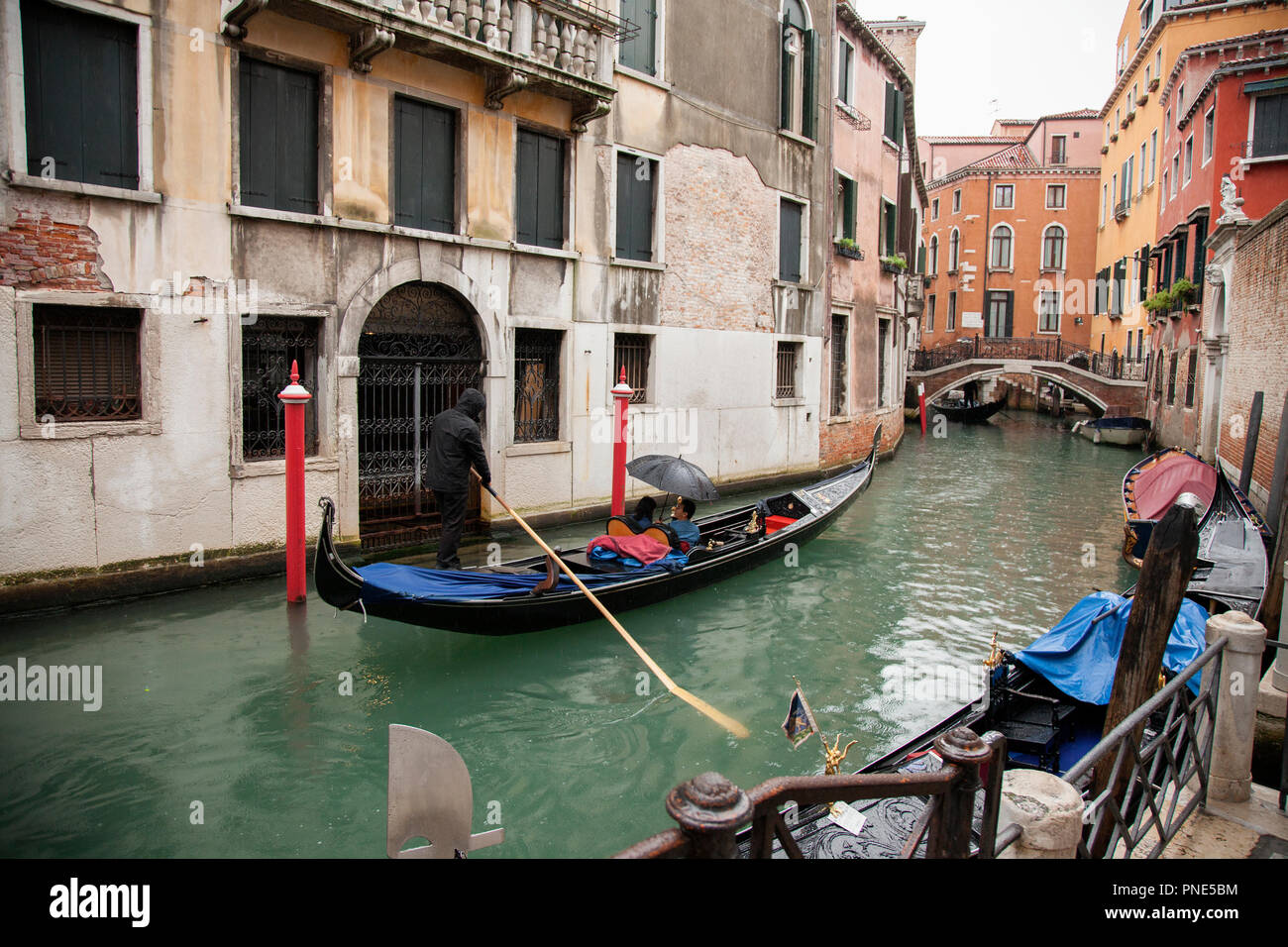 Couple Taking A Romantic Gondola Ride Through The Canals In Venice