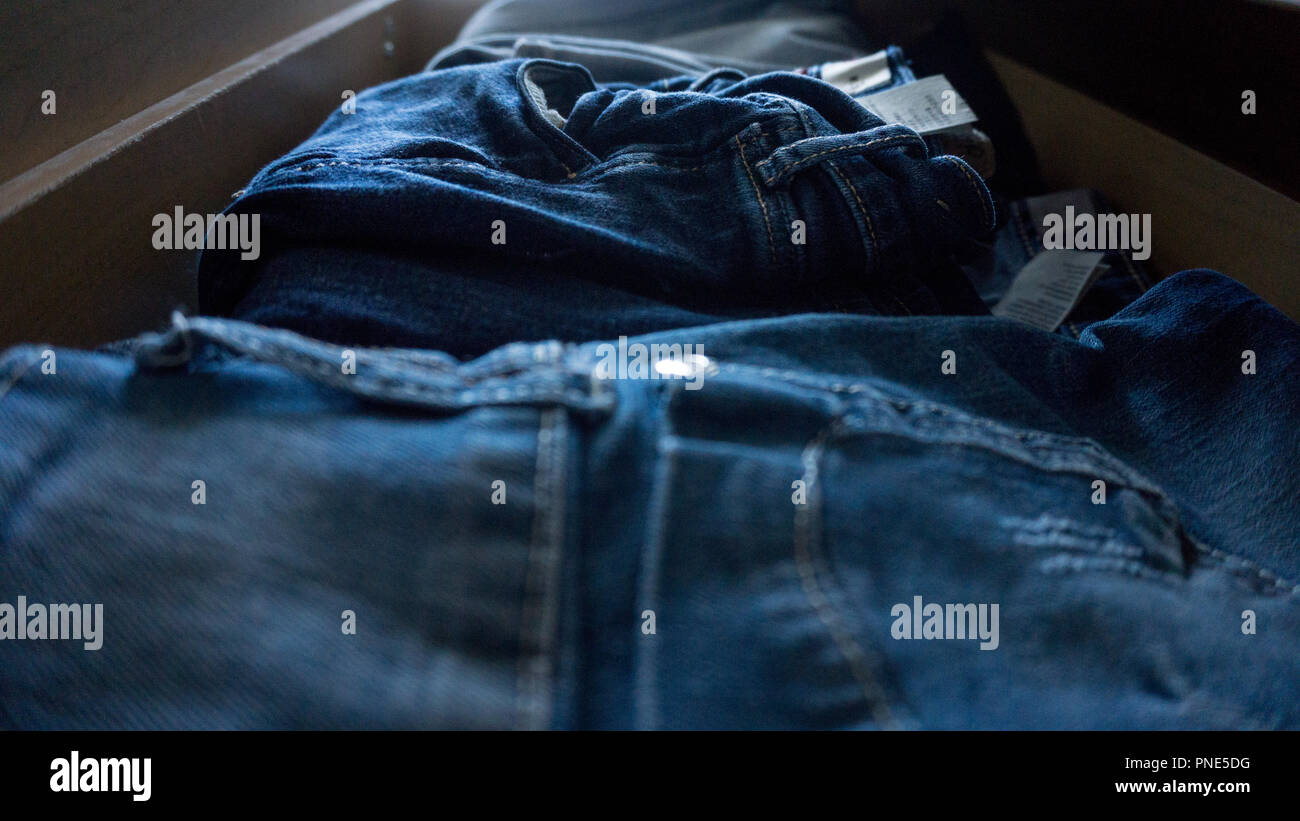 Denim trousers pants drawer folded Stock Photo - Alamy