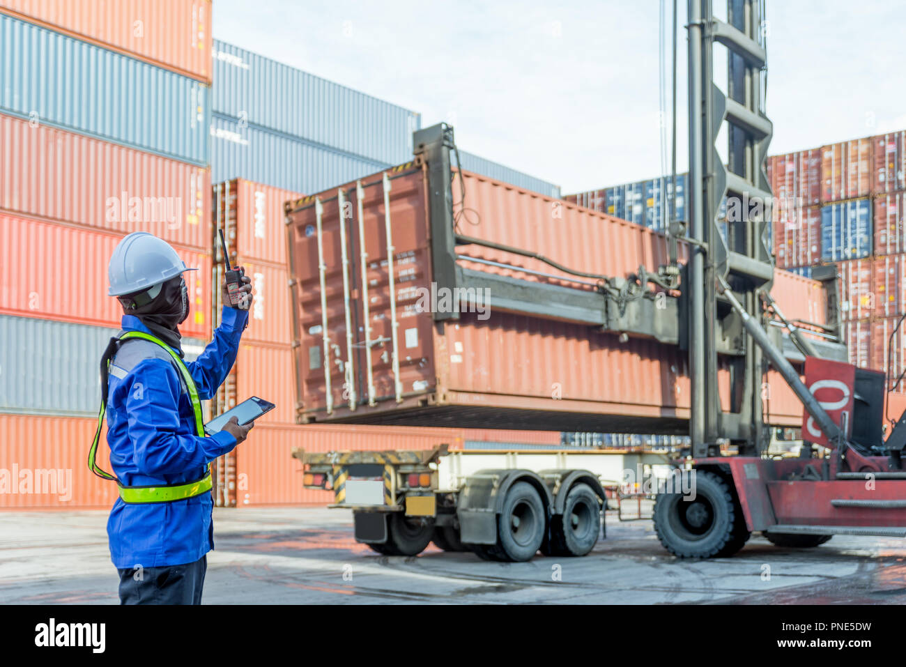 Foreman control loading Containers box from Cargo freight ship for ...