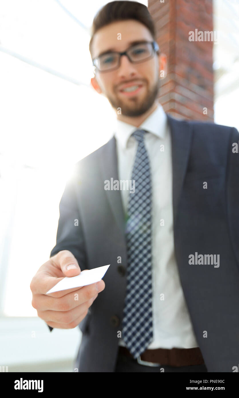 Businessman giving a card. Close-up photo in loft office Stock Photo ...