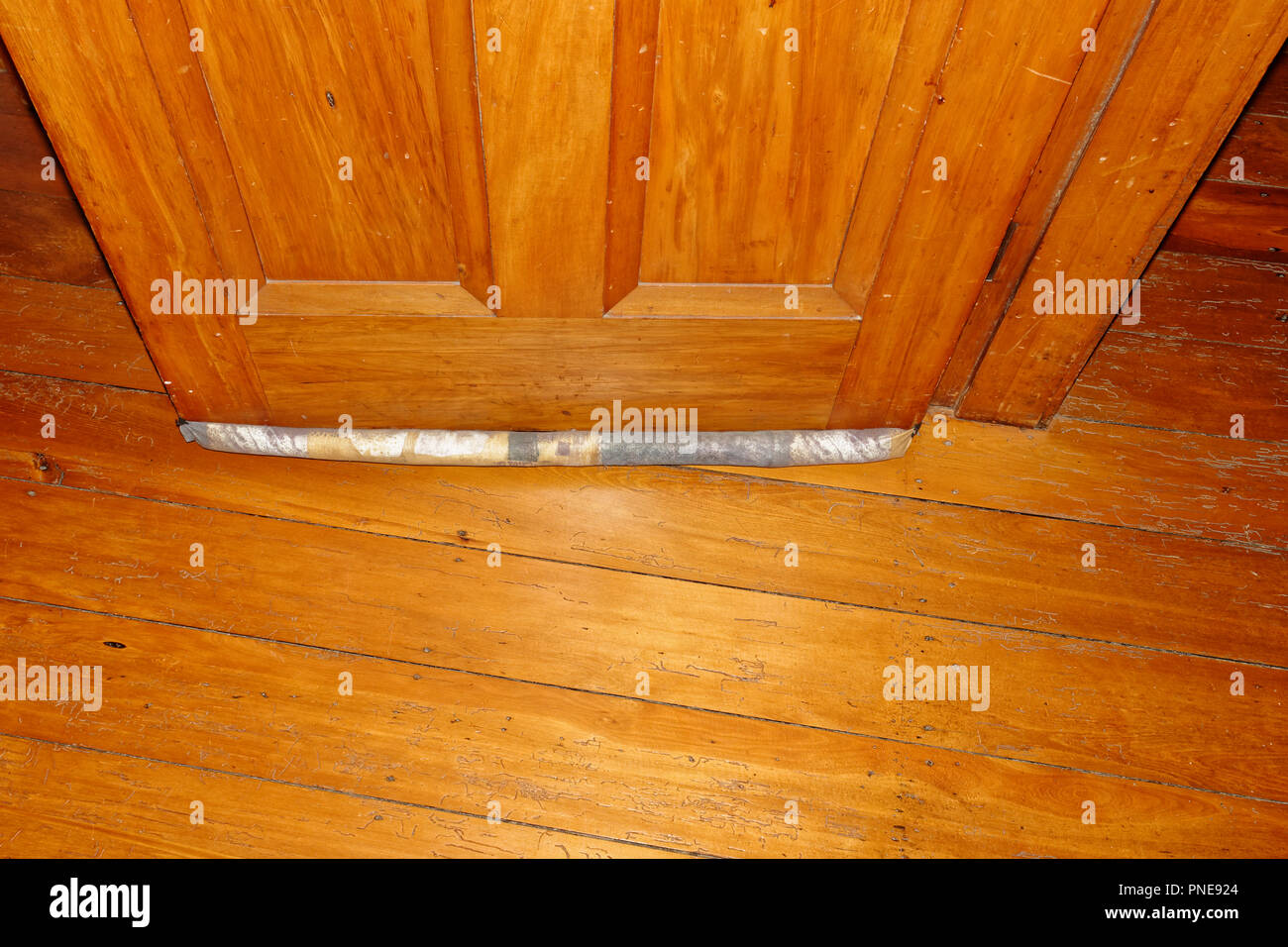 Aerial view looking down a wooden door at the draught excluder on the ...