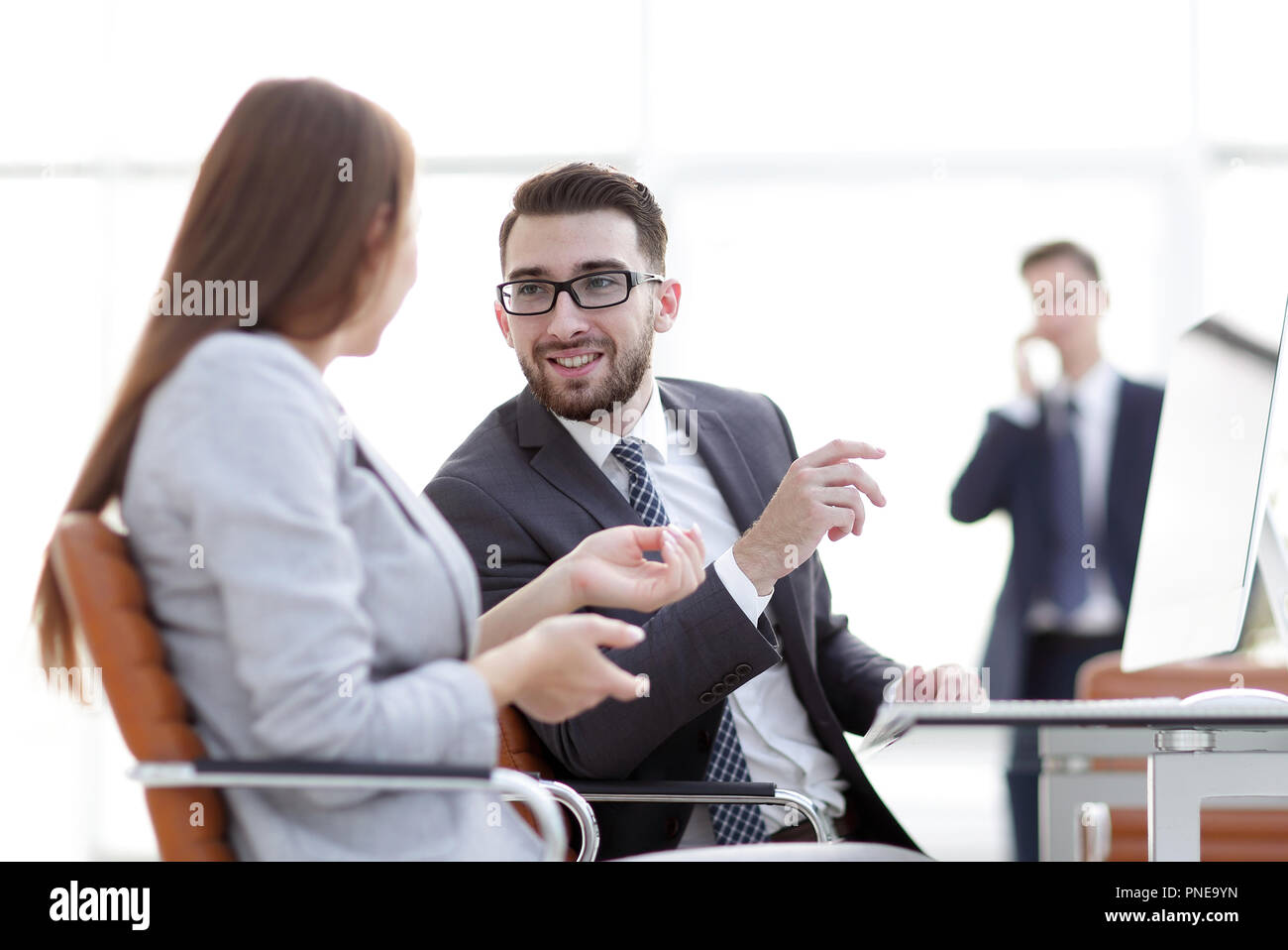 business colleagues talking at their Desk Stock Photo - Alamy