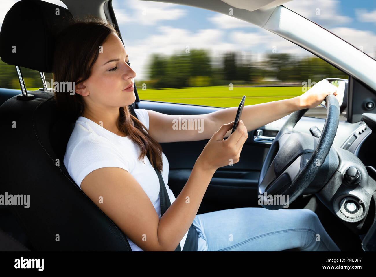 Hand texting while driving hi-res stock photography and images - Alamy