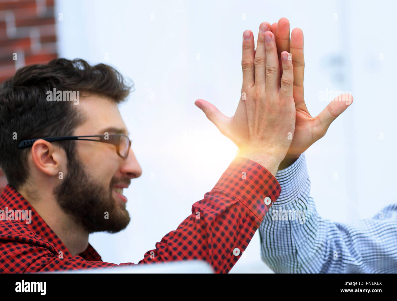 closeup.colleagues giving each other high five Stock Photo - Alamy