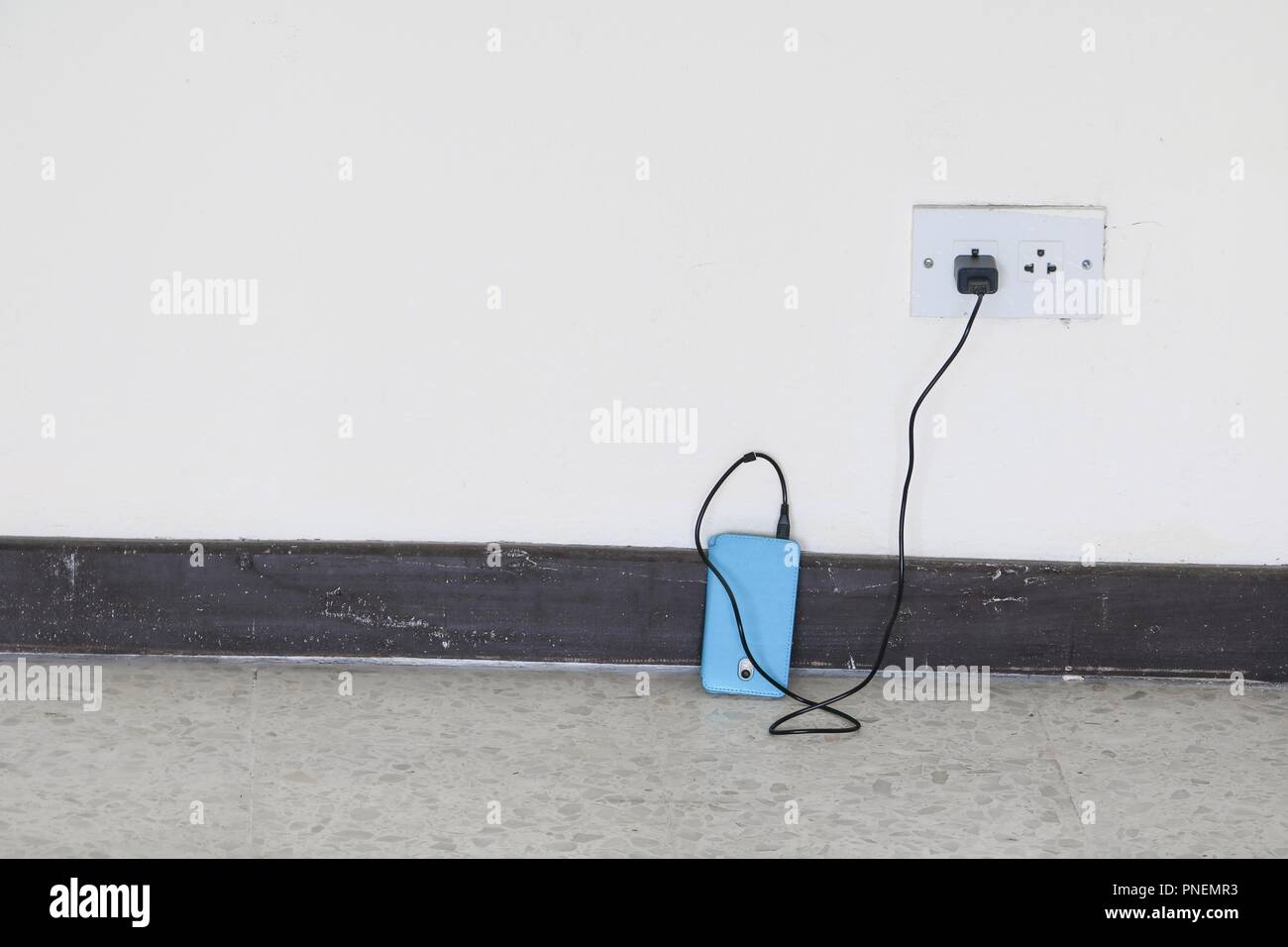 mobile phone charging with socket electricity on wall Stock Photo - Alamy