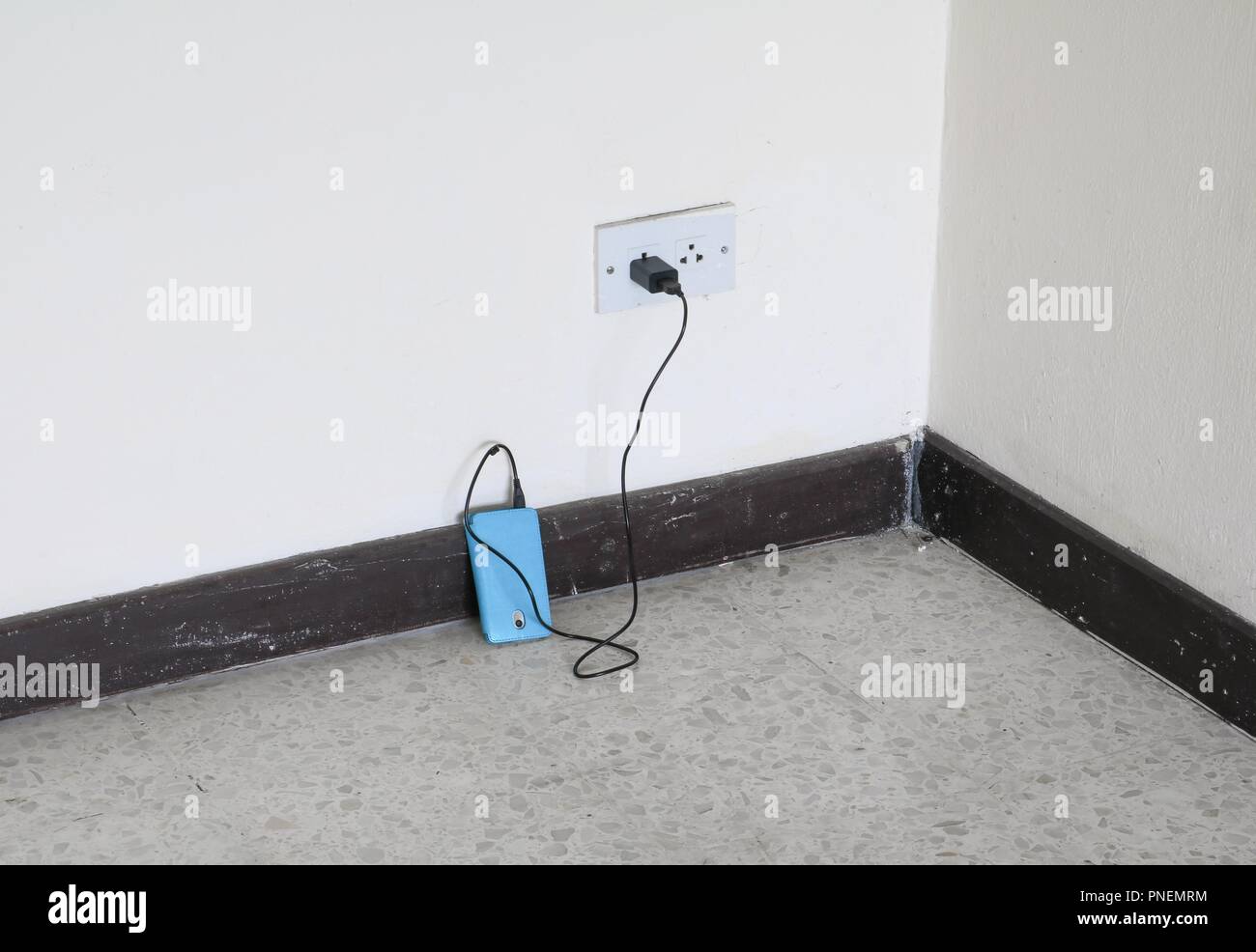 mobile phone charging with socket electricity on wall Stock Photo - Alamy